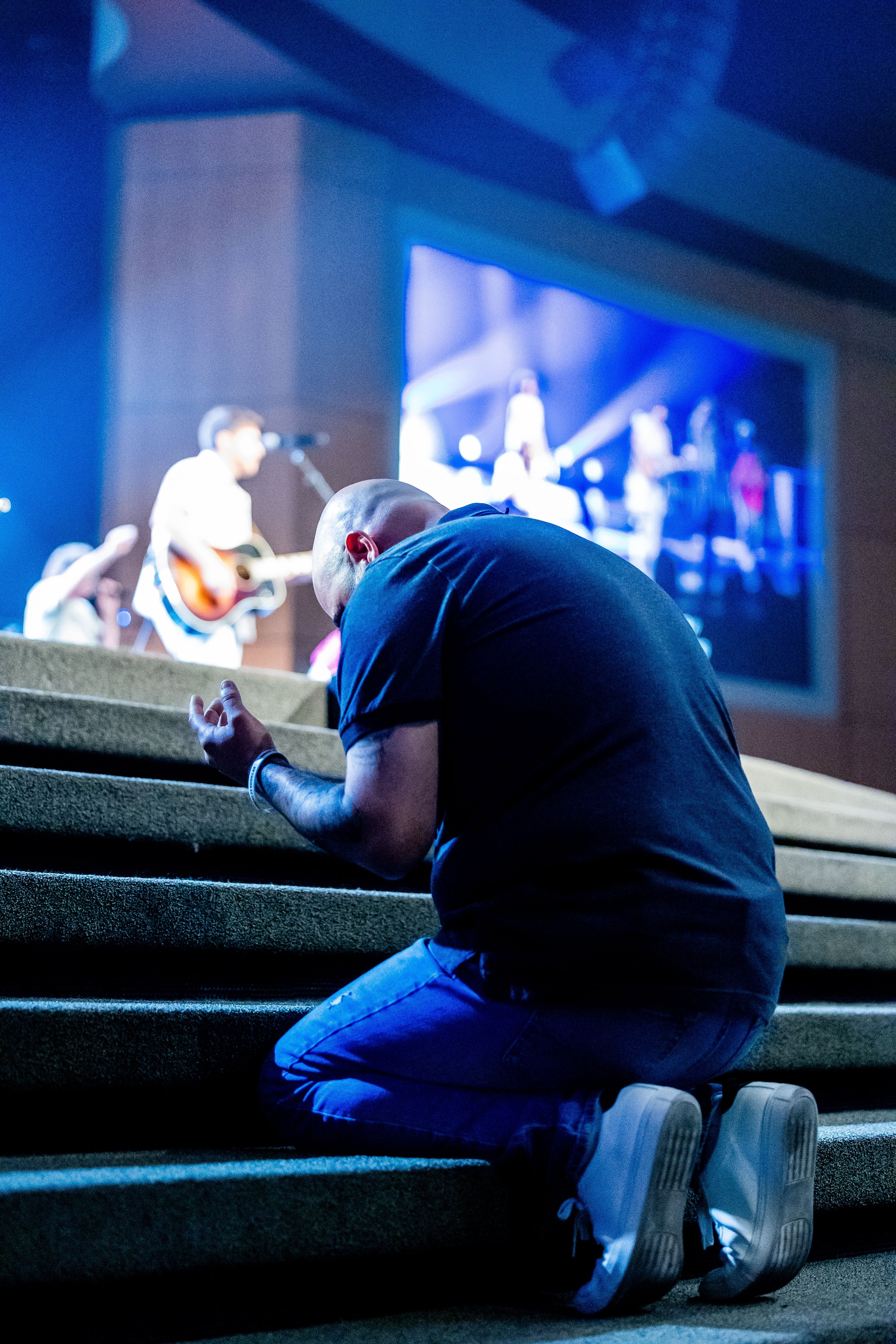 Man Praying in Church with Live Band · Free Stock Photo