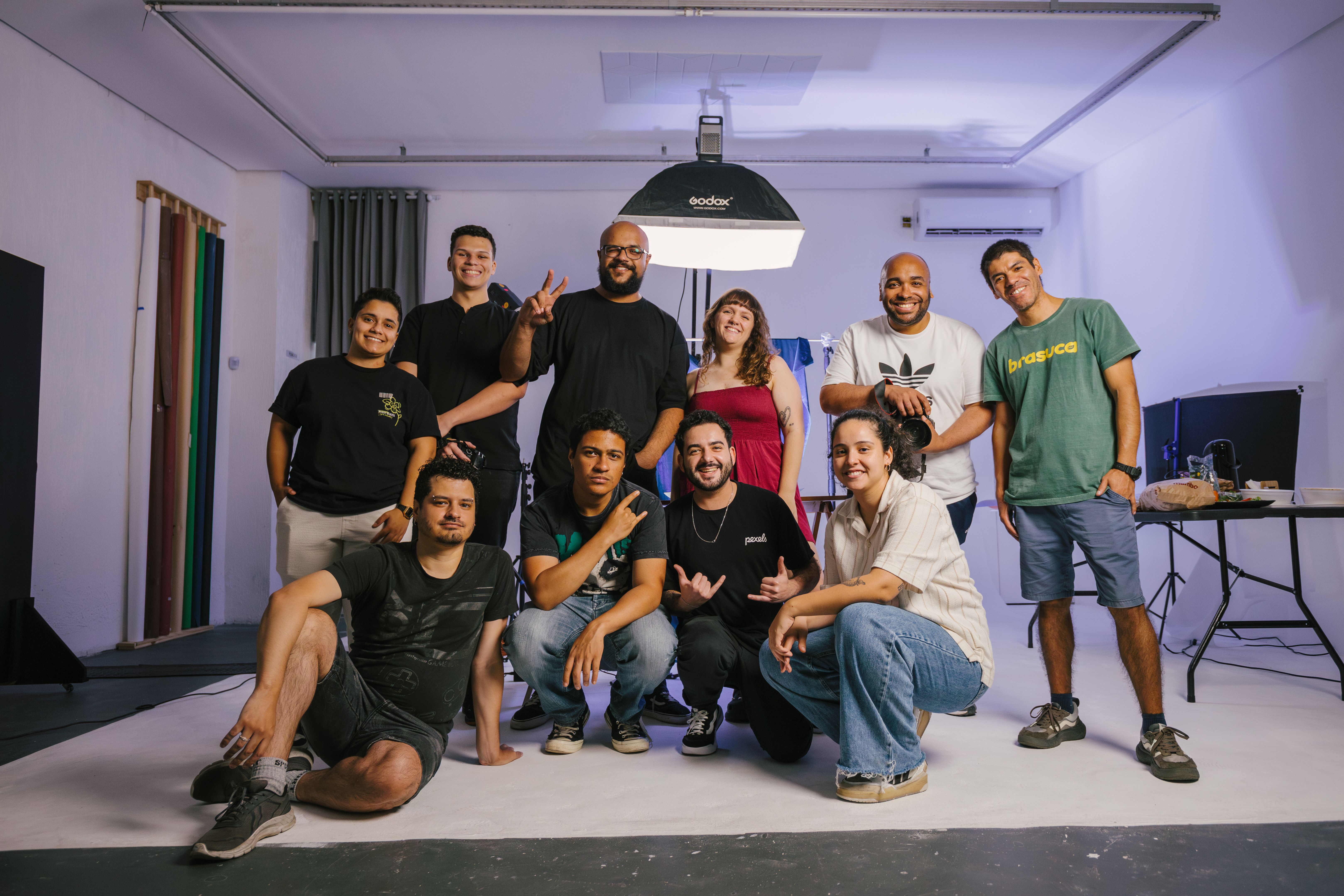 Diverse Group Poses Cheerfully in Photography Studio · Free Stock Photo