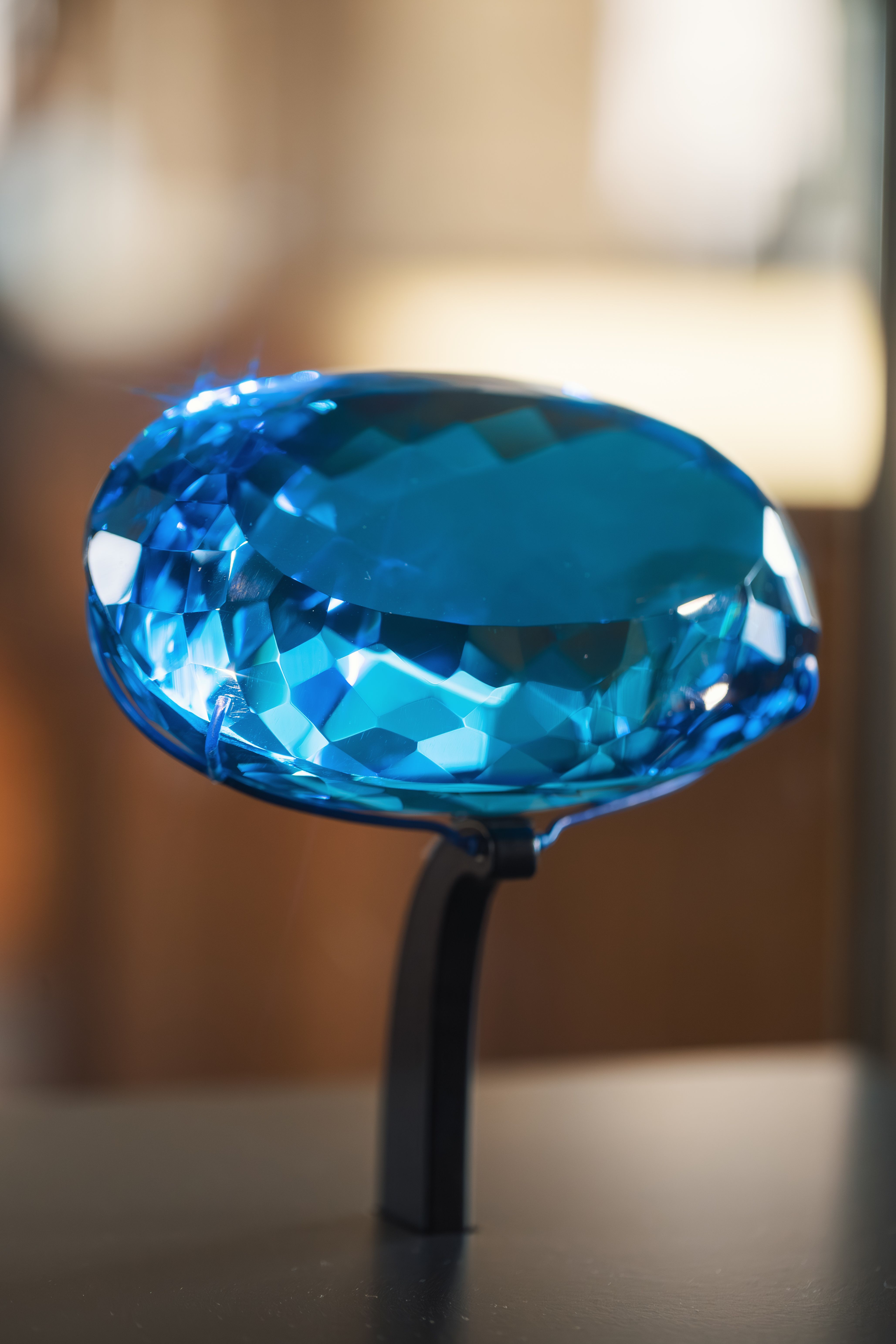 Close-Up of a Blue Gemstone on Display Stand · Free Stock Photo