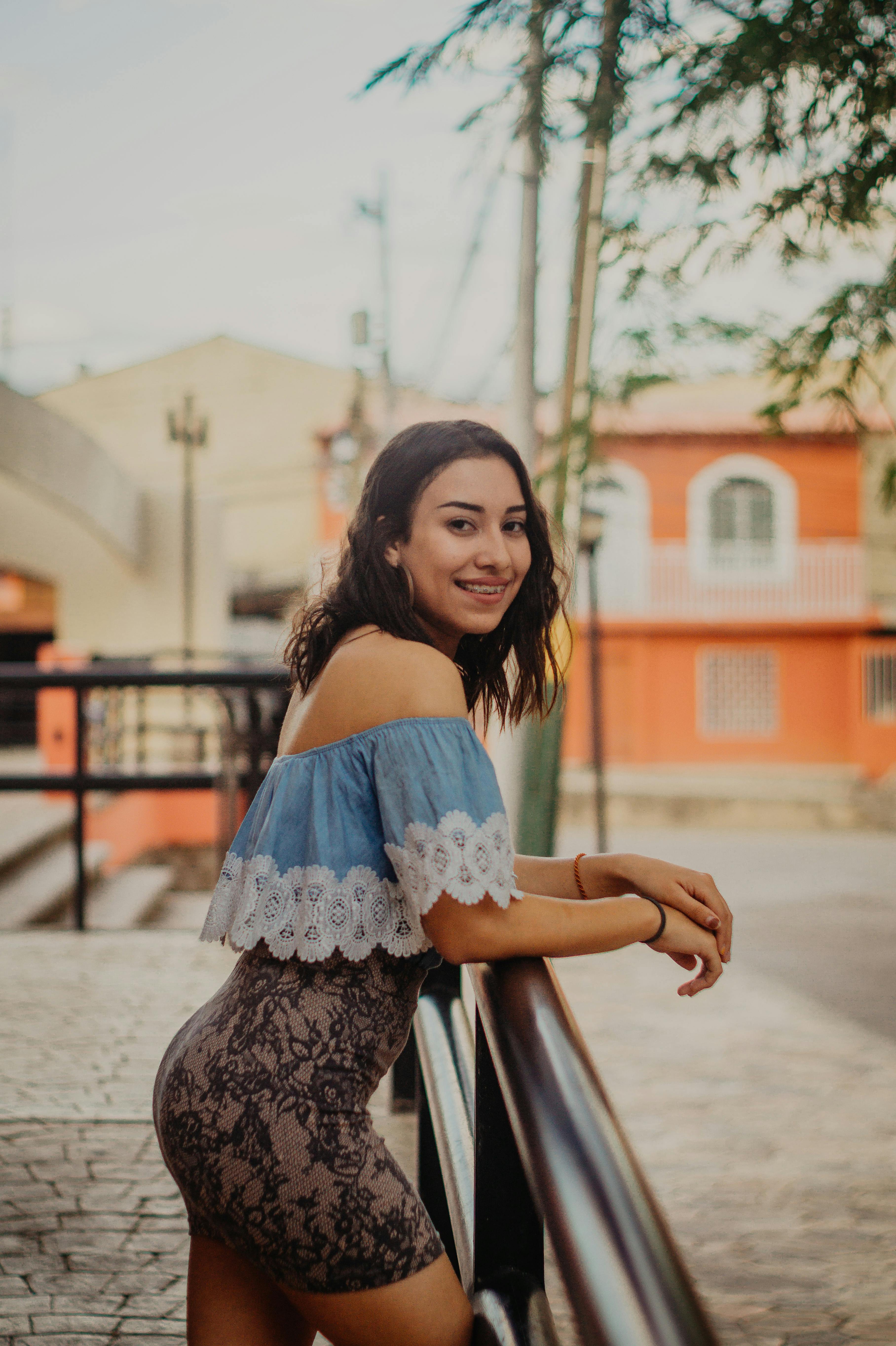 Photo of Woman Leaning on Handrail · Free Stock Photo