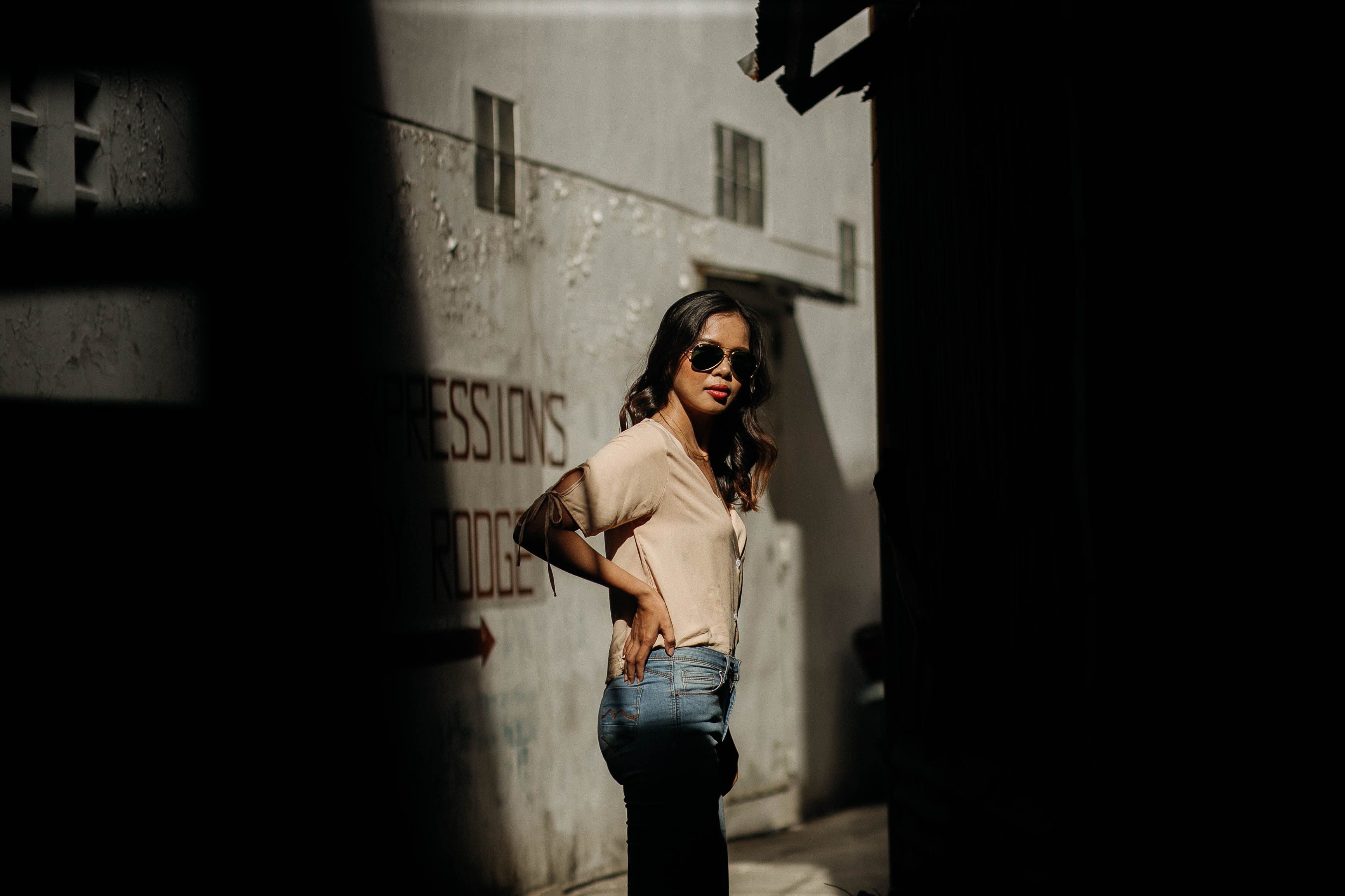 Woman Standing Beside Building · Free Stock Photo