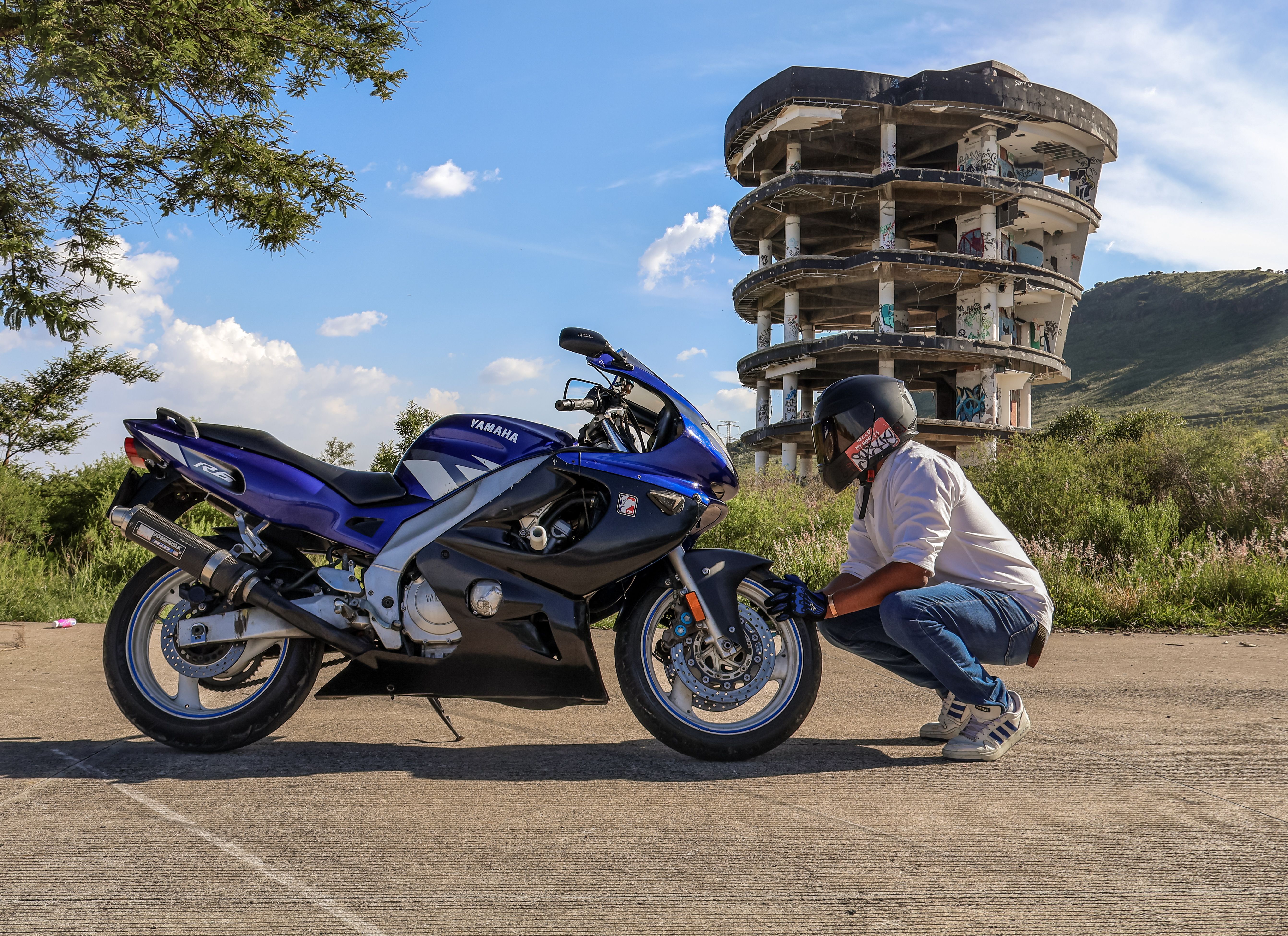 Motorcycle maintenance in urban outdoor setting · Free Stock Photo