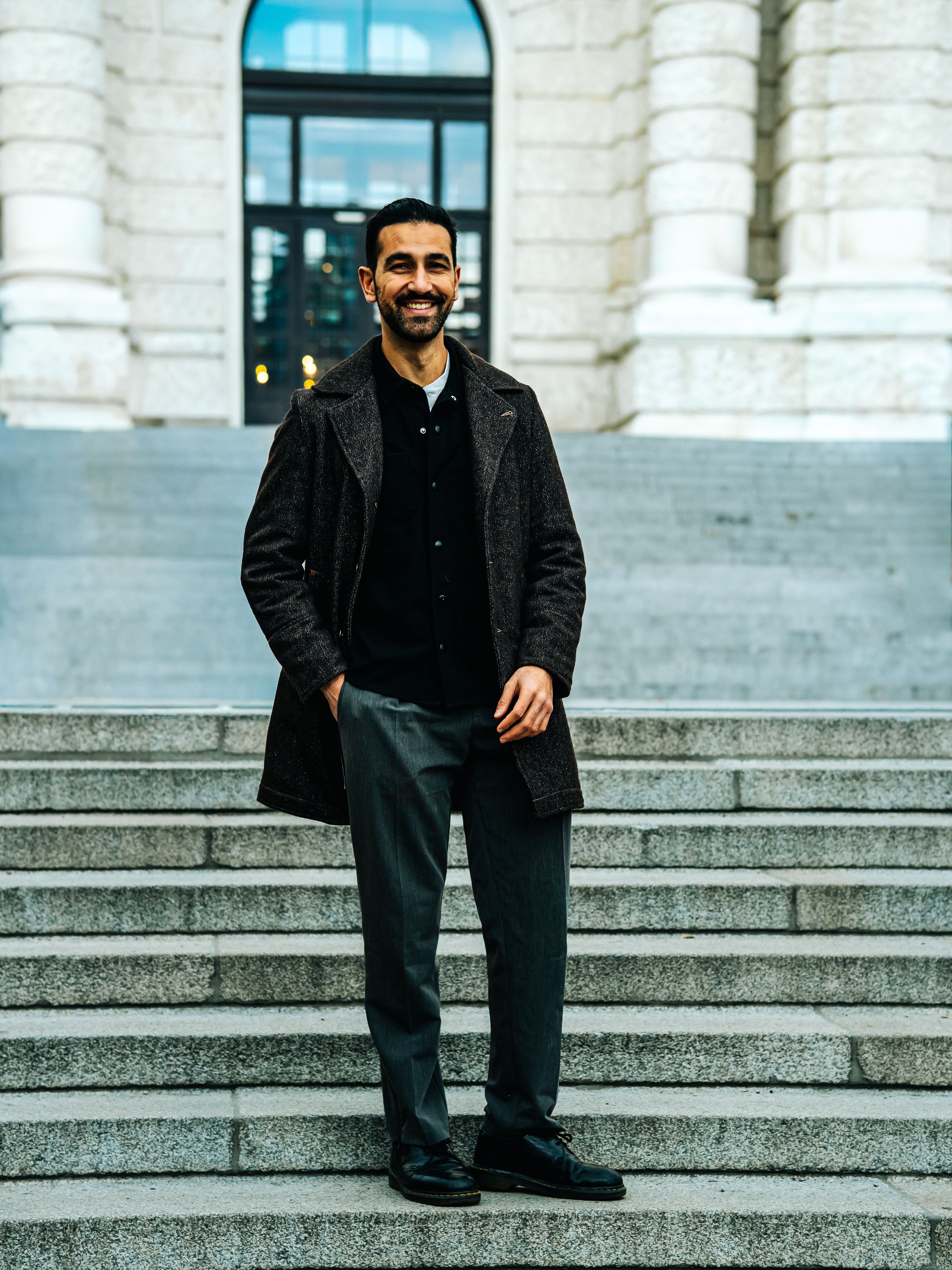 Man standing on stone steps in stylish coat · Free Stock Photo