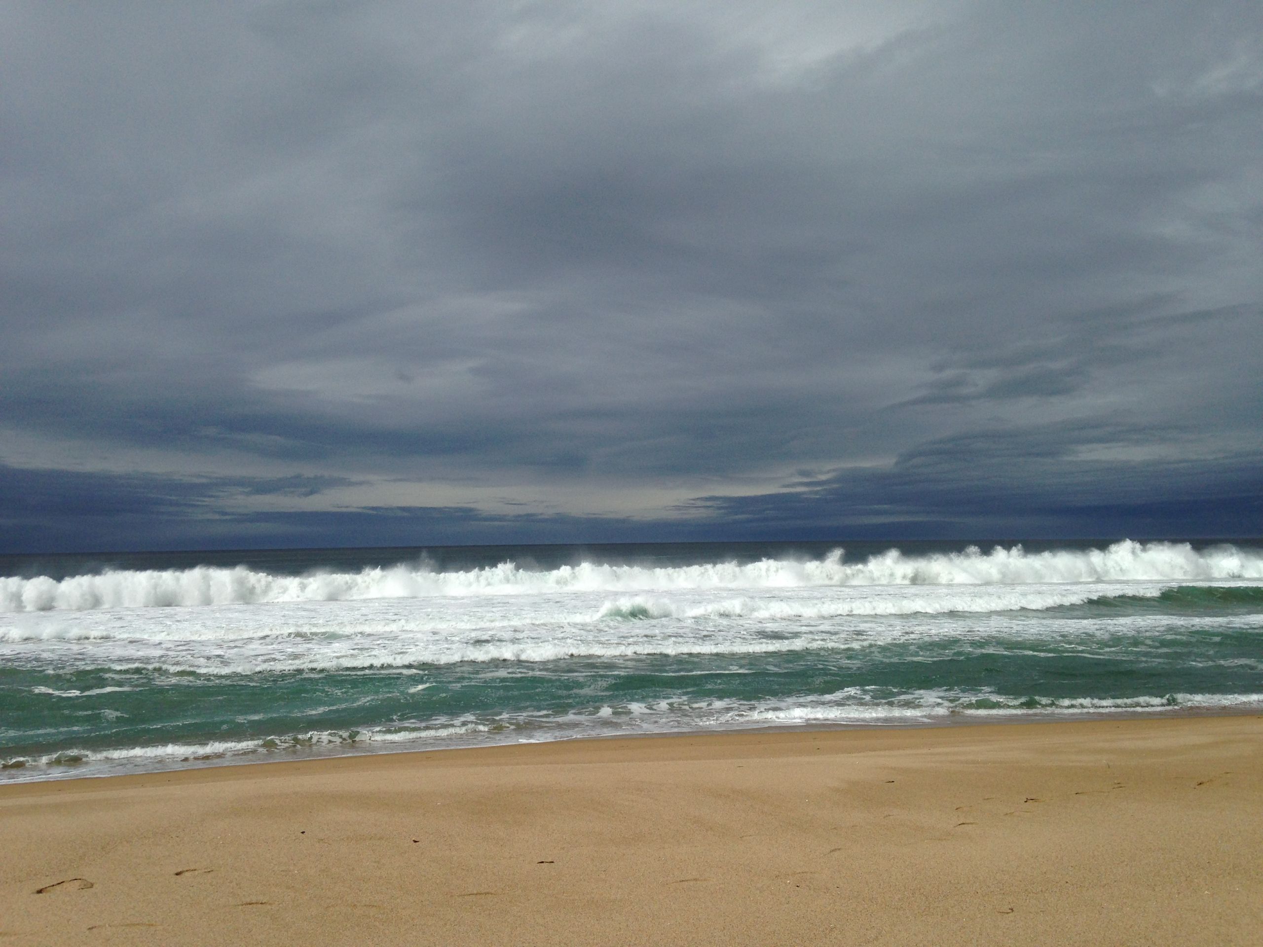 Dramatic Ocean Waves Under Cloudy Skies · Free Stock Photo