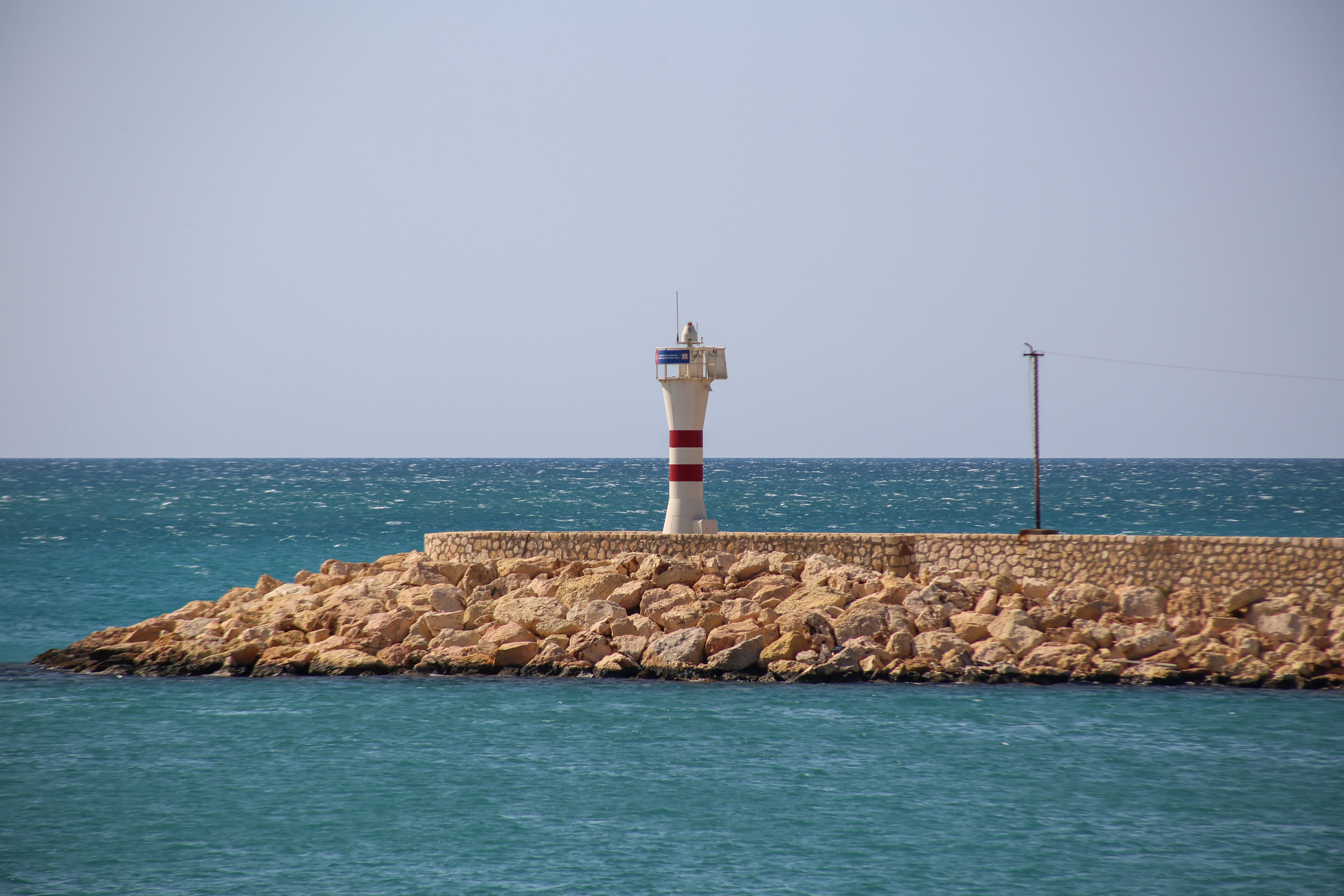 Seaside Lighthouse on Rocky Pier · Free Stock Photo