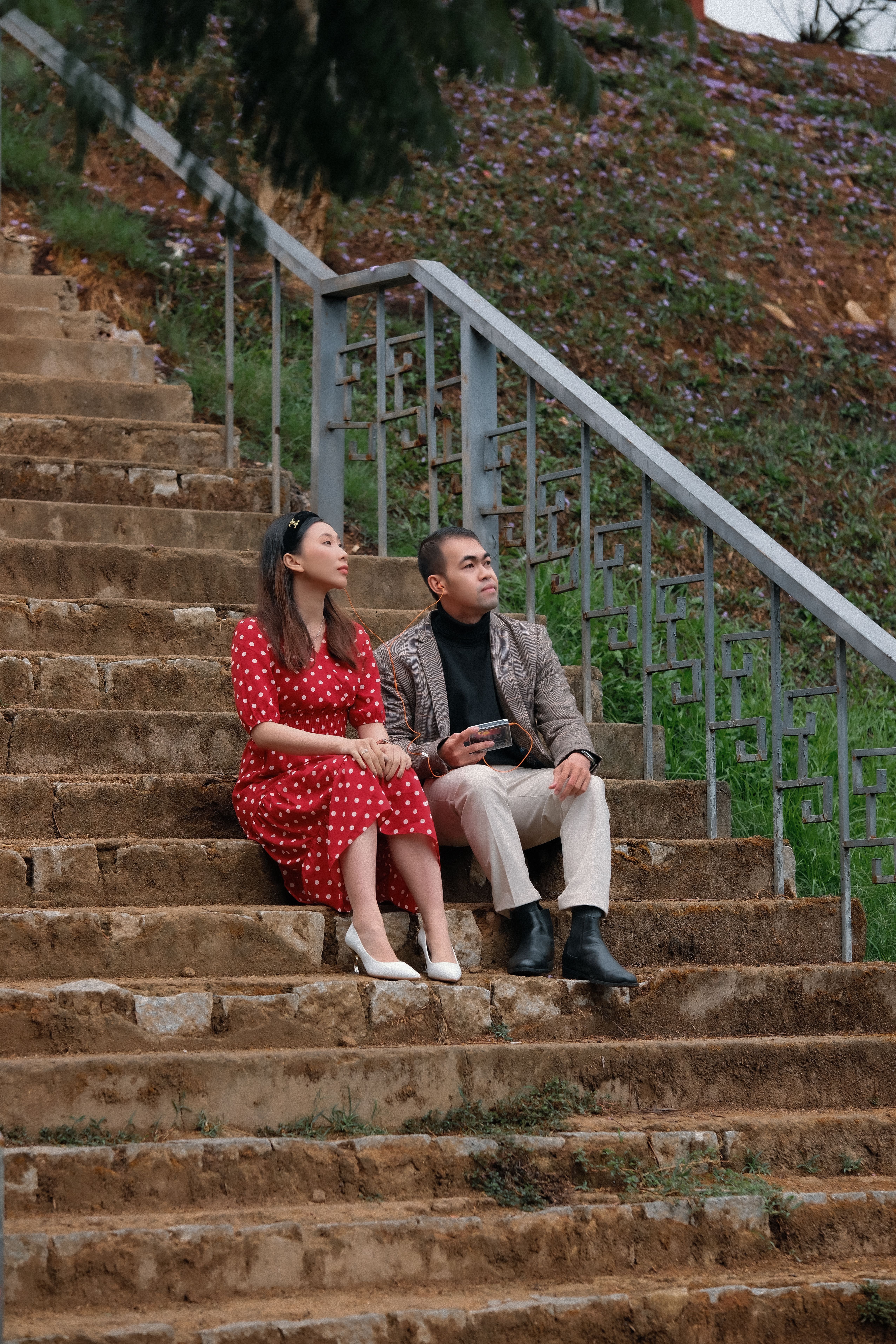 Couple Seated on Outdoor Stone Steps Relaxing · Free Stock Photo