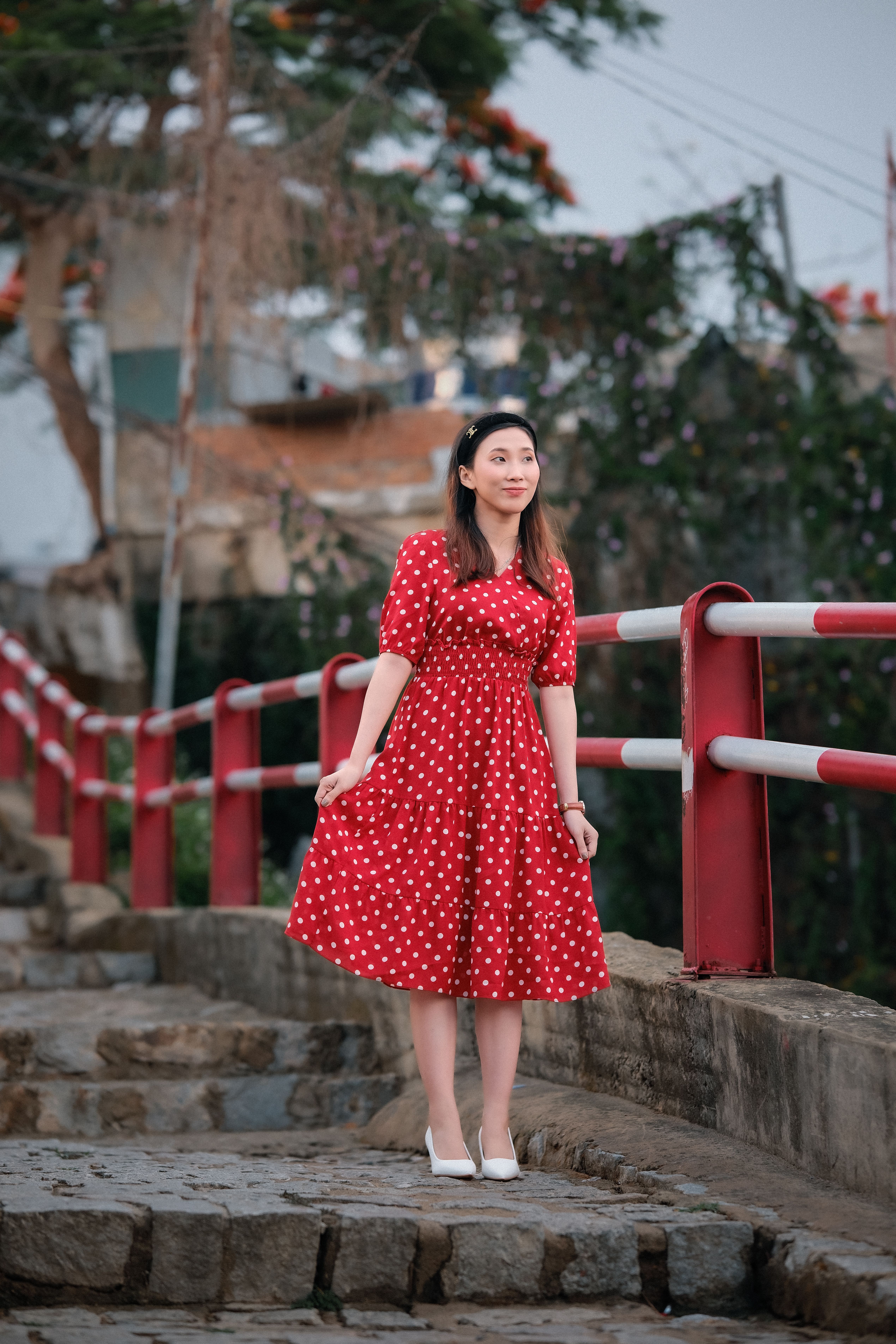 Woman in Red Polka Dot Dress Walking Outdoors · Free Stock Photo
