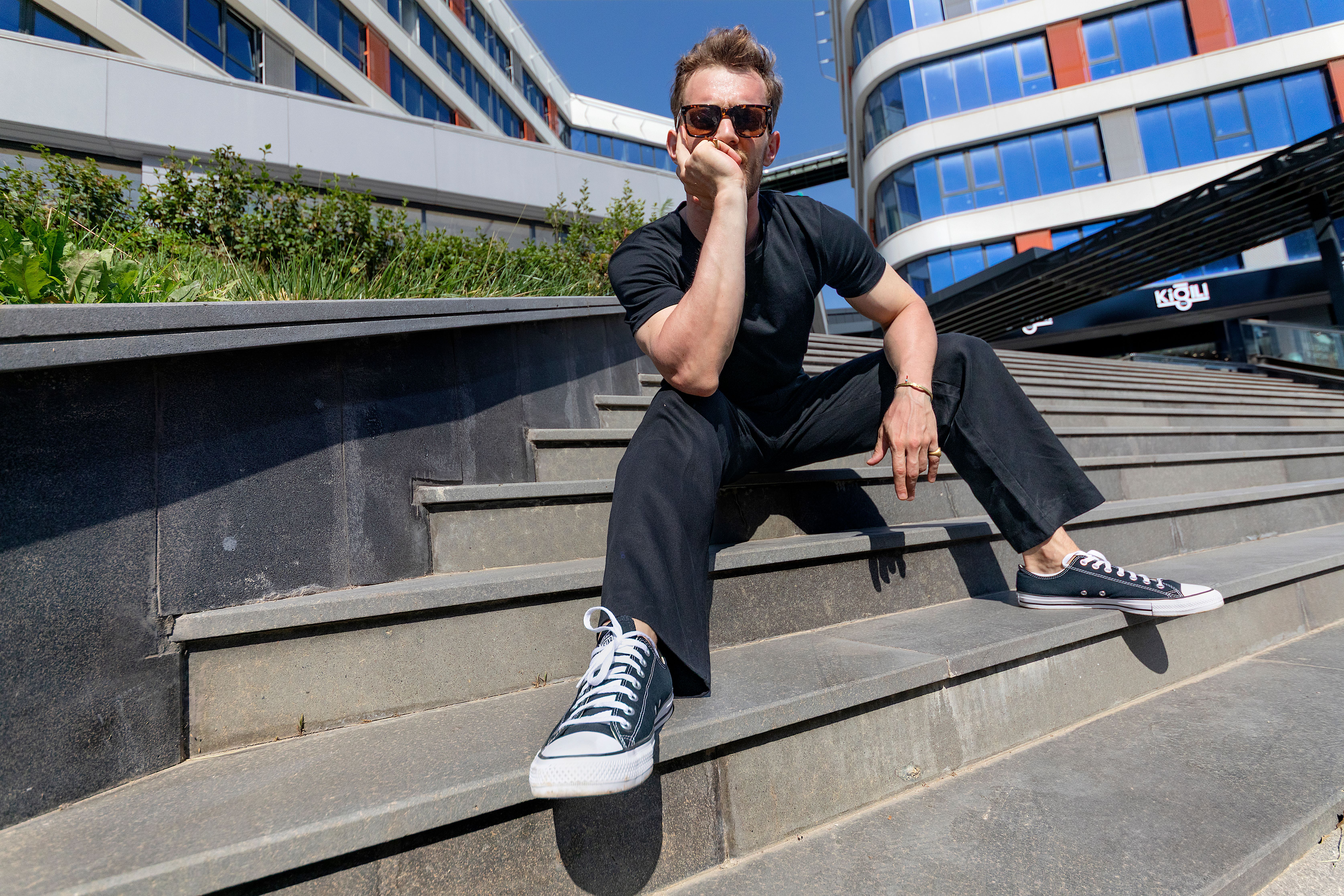 Stylish Man Posing on Urban Steps in Daylight · Free Stock Photo