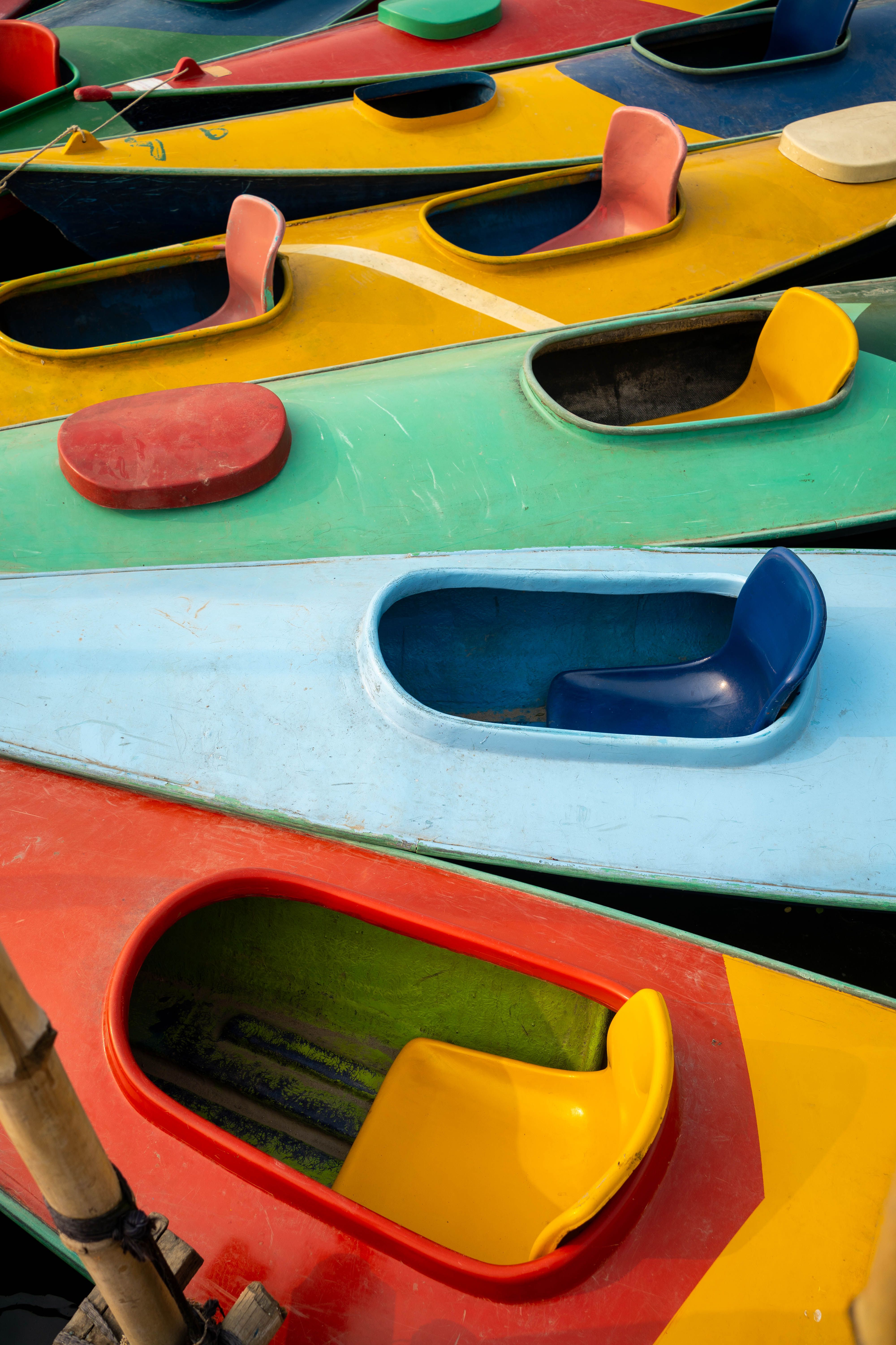 Colorful Canoes Aligned in a Marina · Free Stock Photo