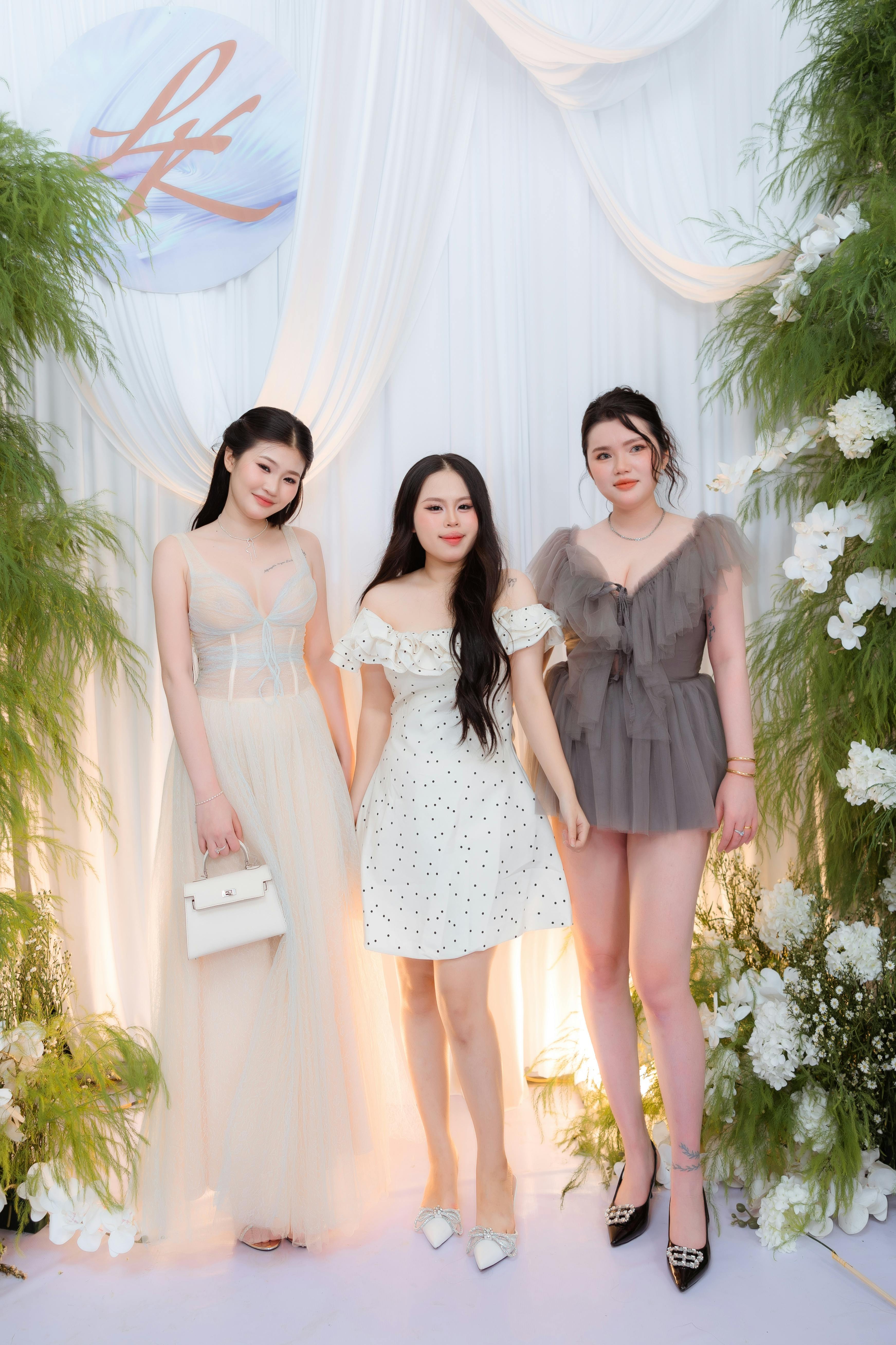 Elegant Trio in Stylish Dresses at Event · Free Stock Photo