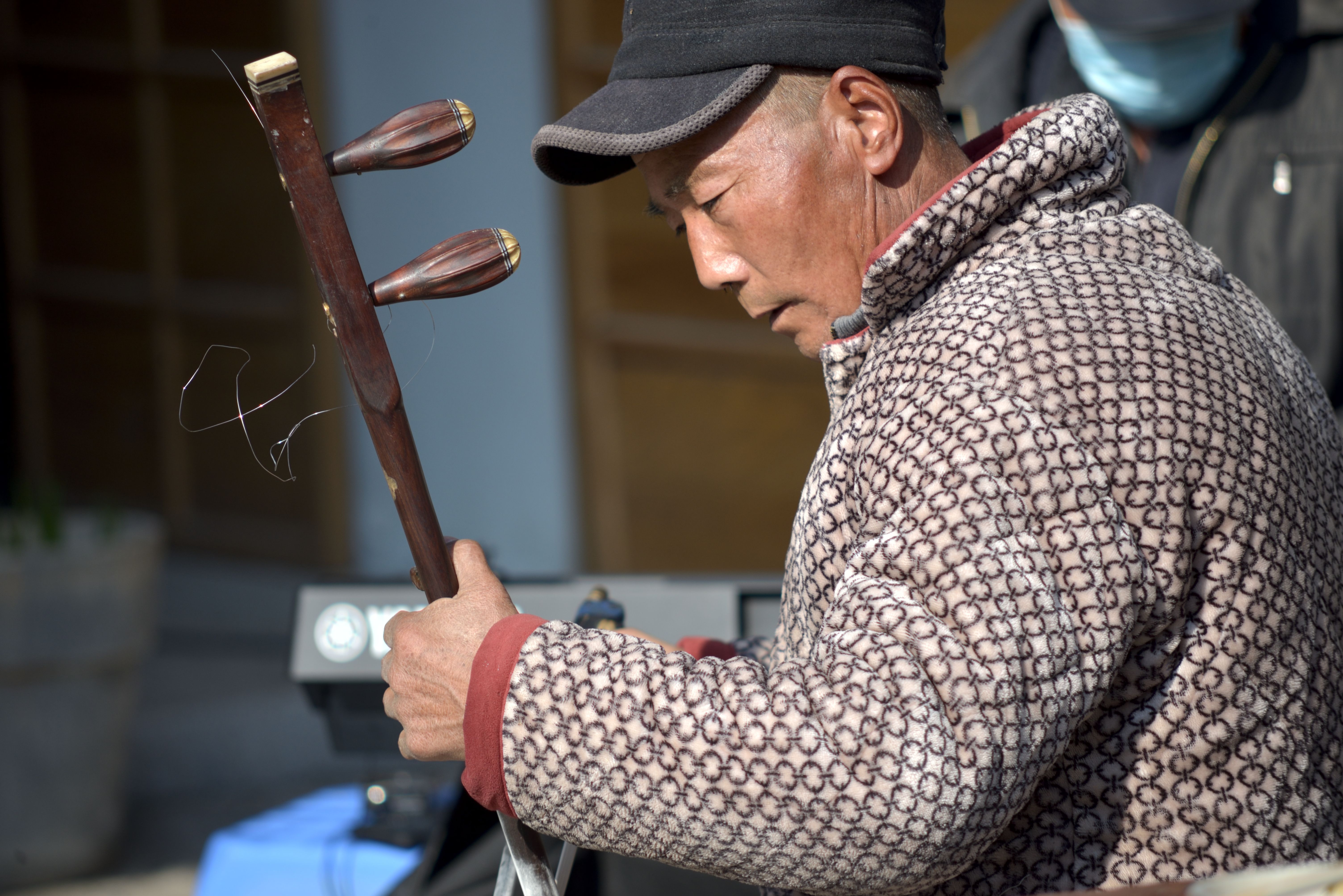 Man Playing Traditional Chinese Erhu Outdoors · Free Stock Photo