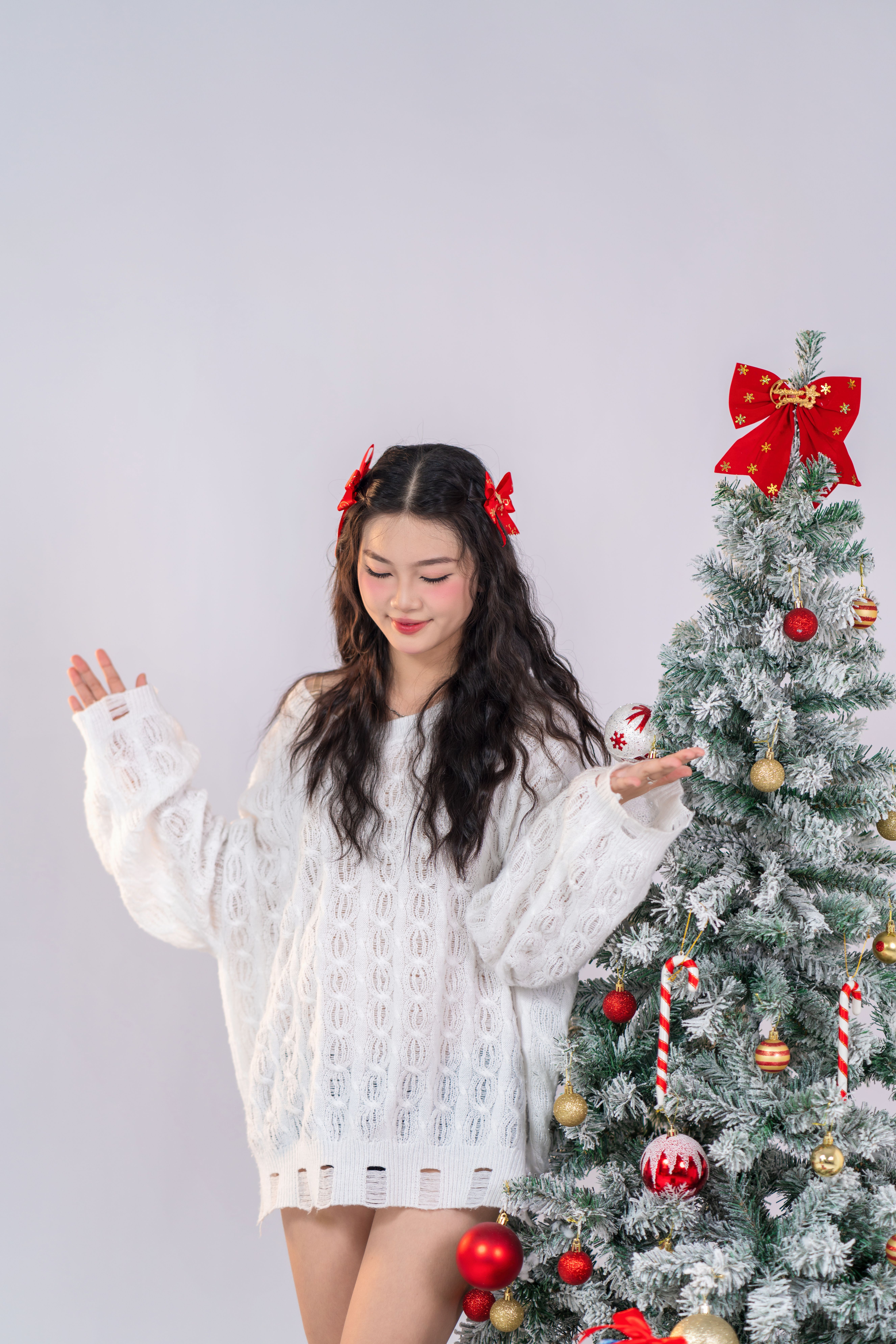Festive Woman Celebrating by Christmas Tree · Free Stock Photo