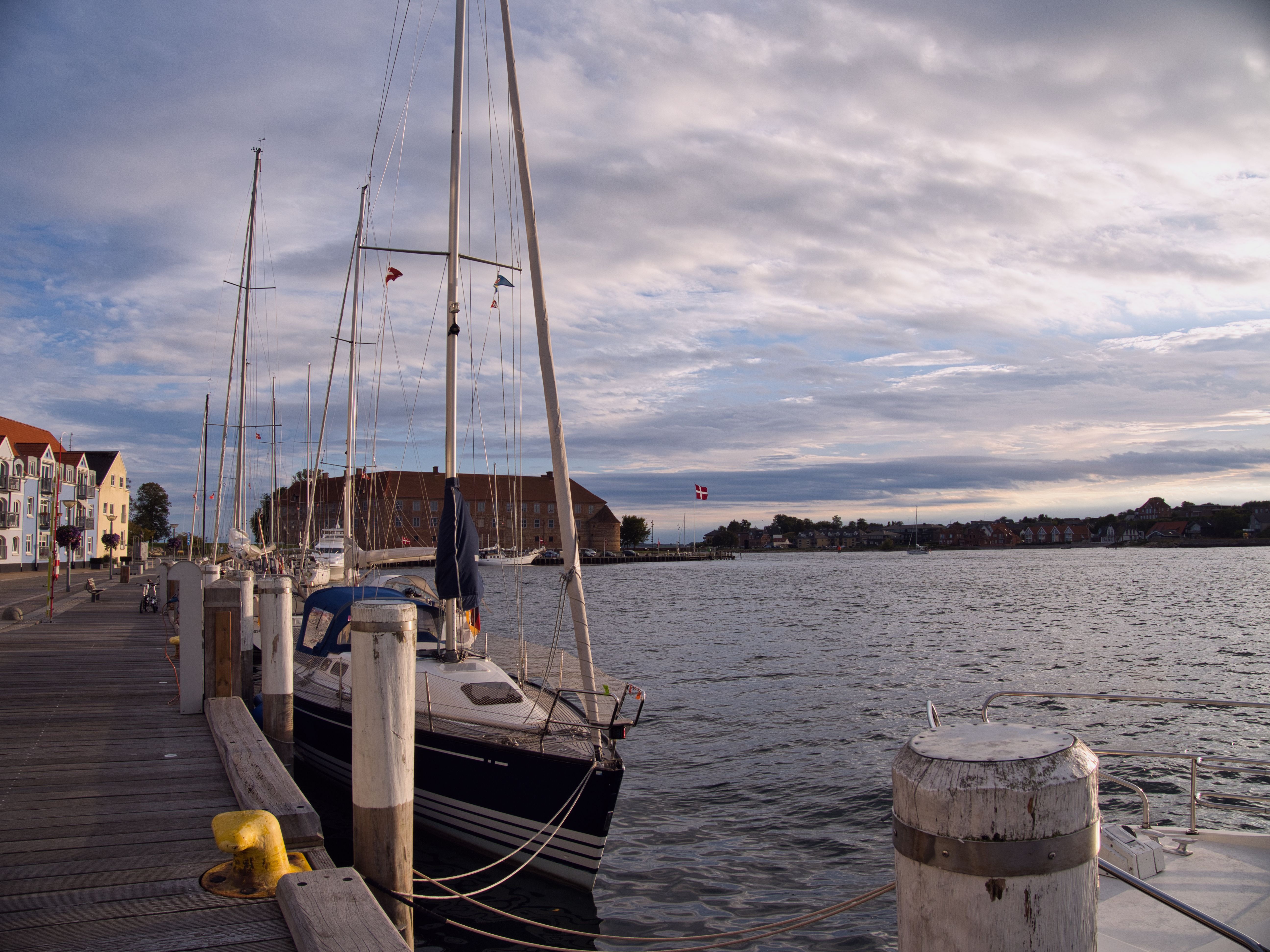 Scenic Harbor View with Sailboats at Sunset · Free Stock Photo