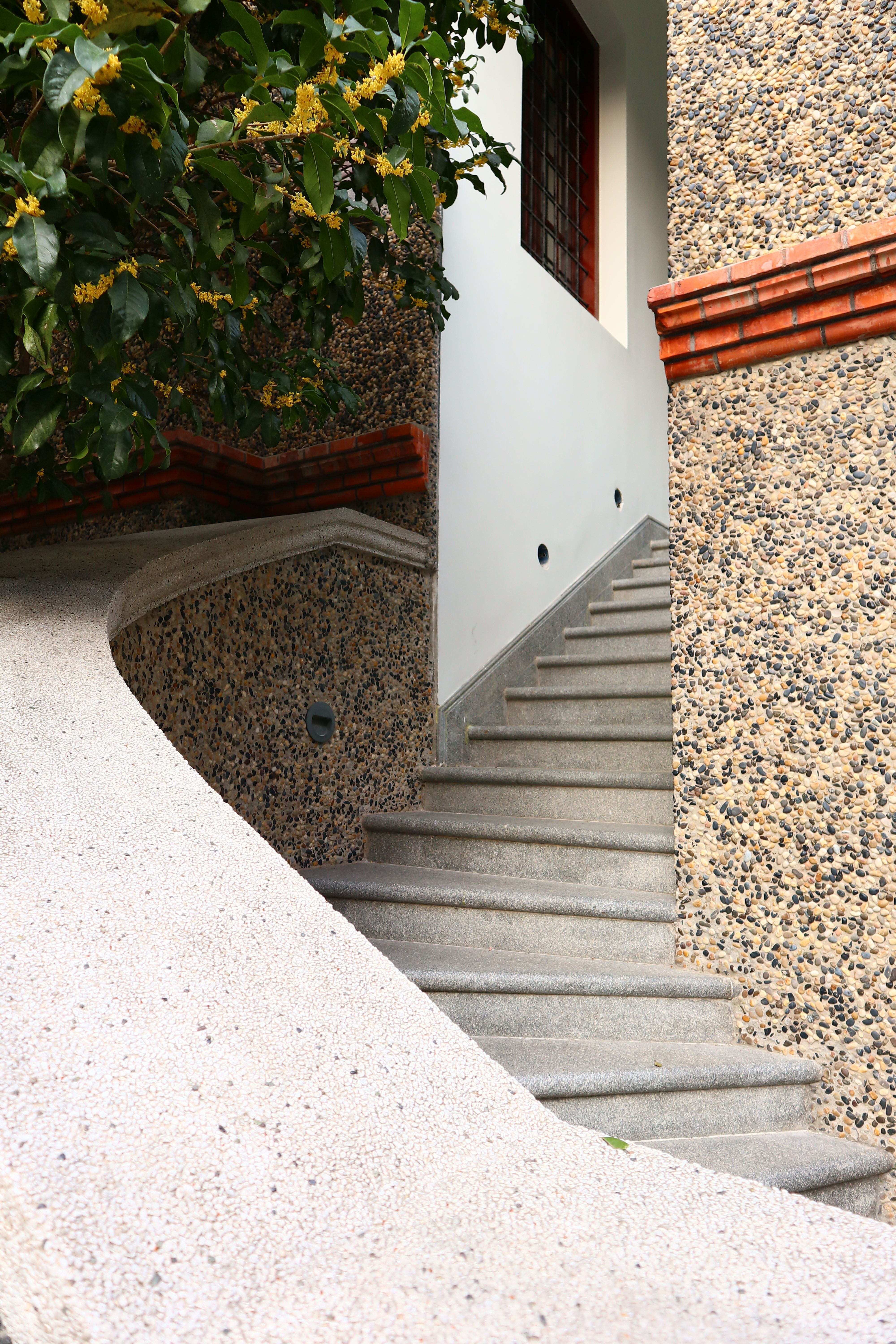 Curved Stone Staircase in Sunlit Courtyard · Free Stock Photo