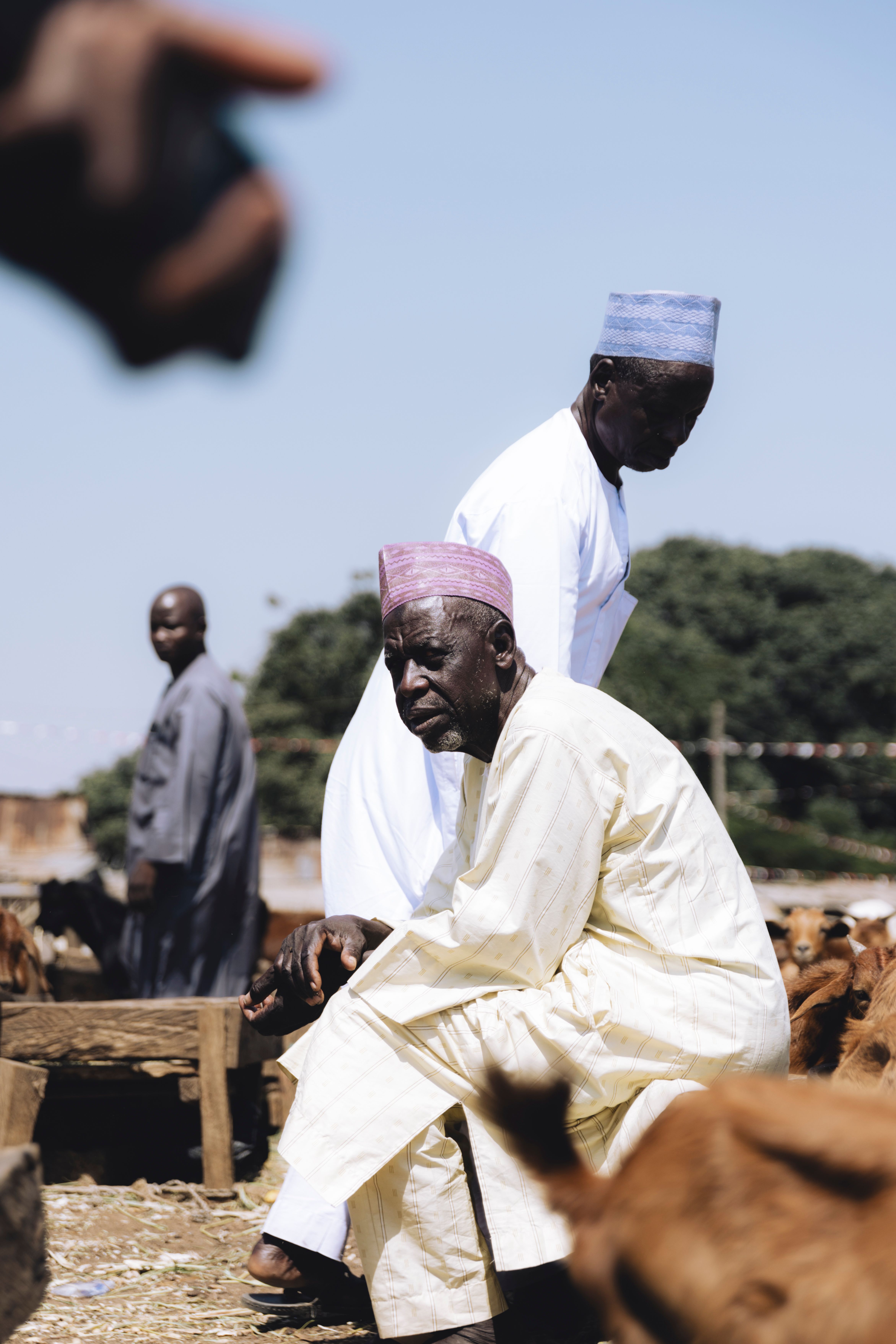 African Men in Traditional Dress at Outdoor Market · Free Stock Photo