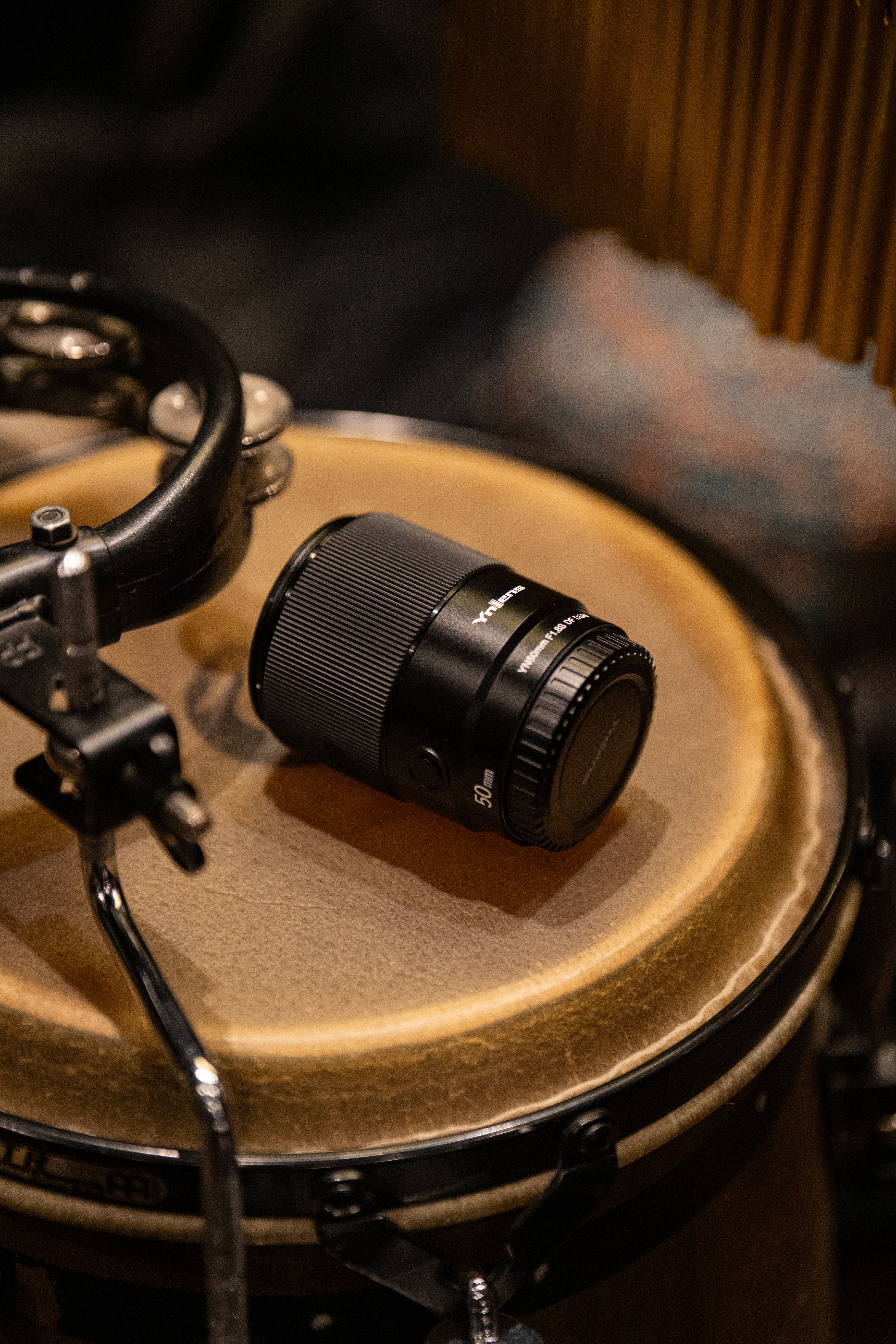 Camera Lens on a Bongo Drum Surface · Free Stock Photo