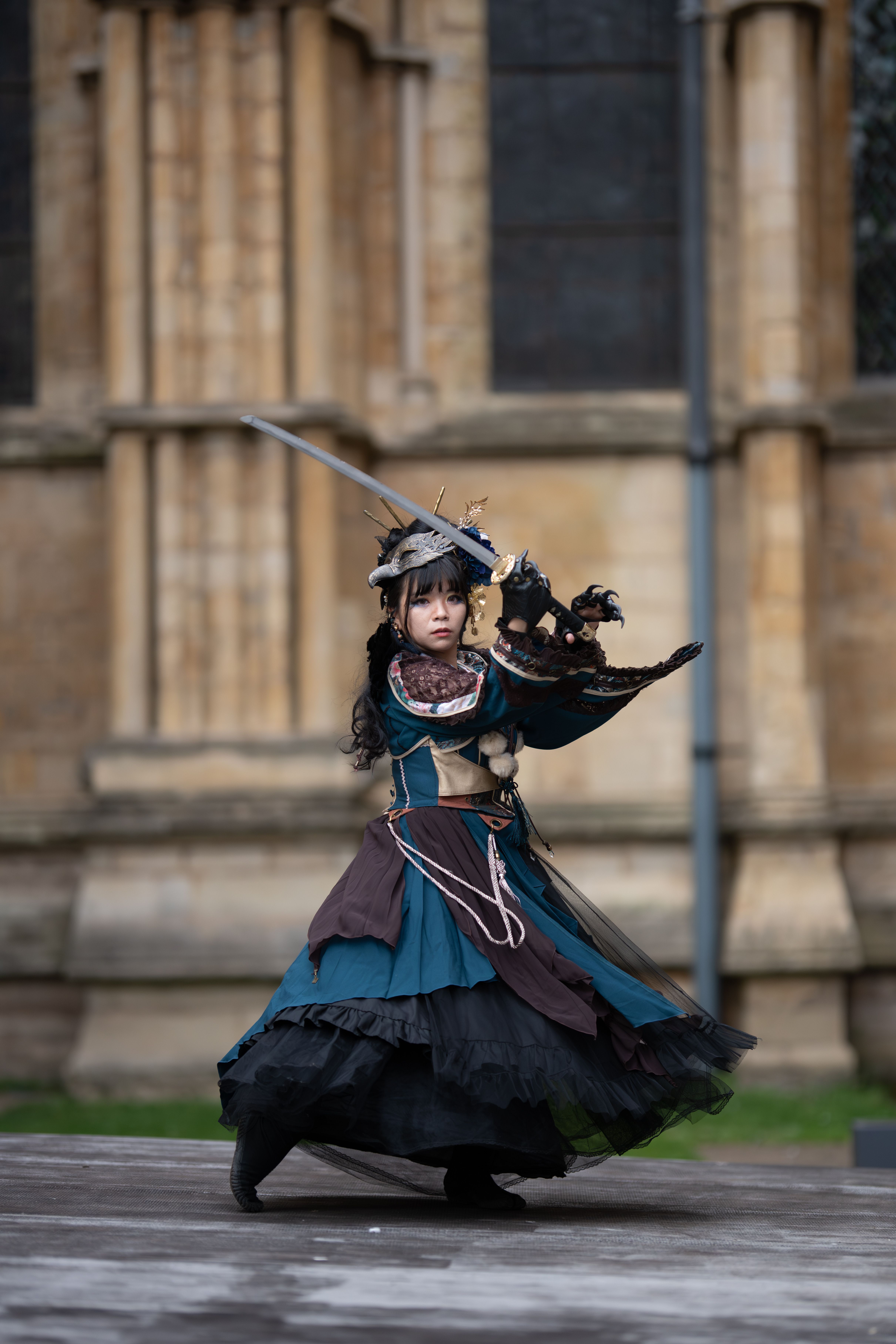 Steampunk Cosplayer Posing with Sword Outdoors · Free Stock Photo