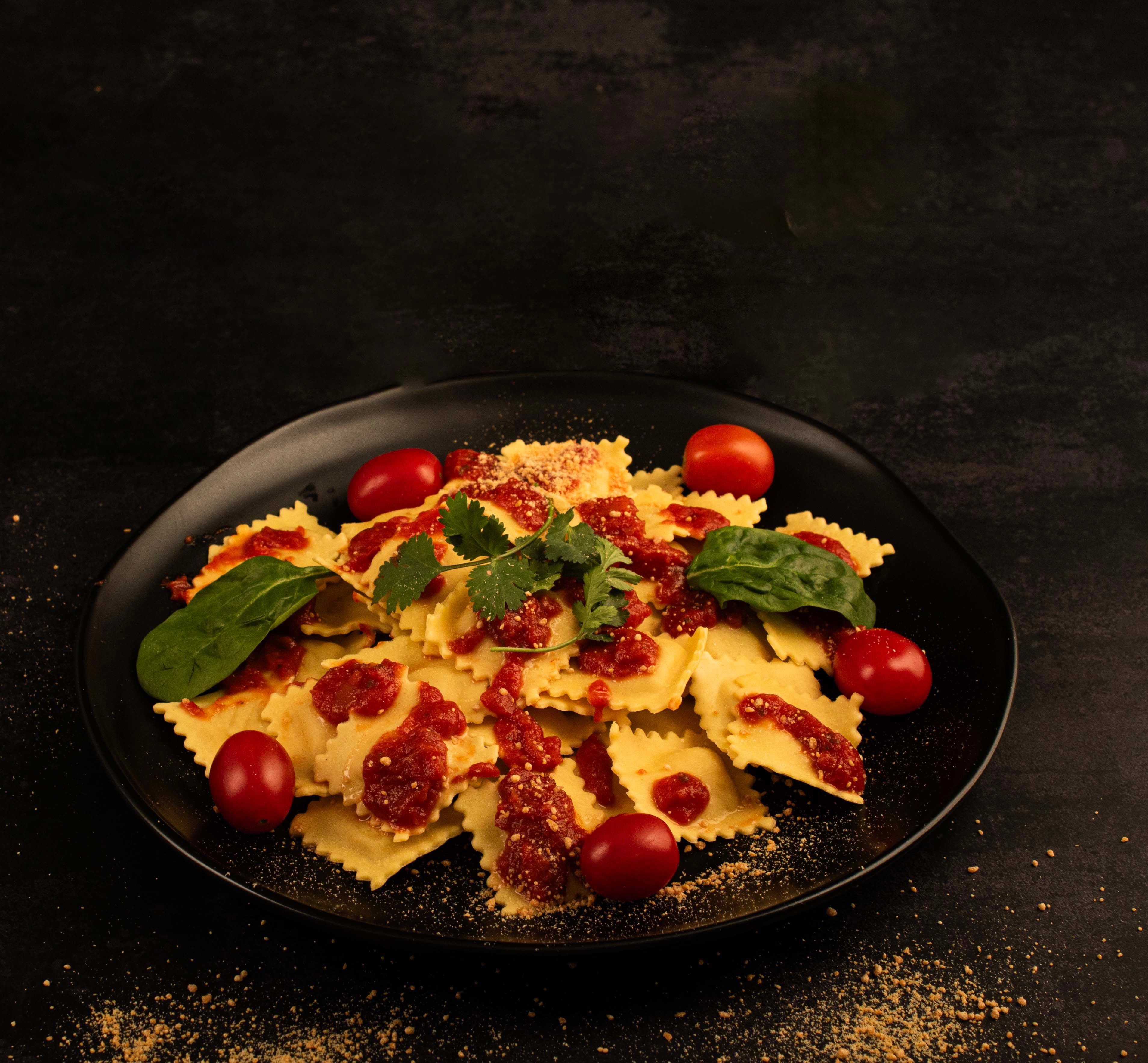 Gourmet Ravioli with Tomato Sauce and Spinach · Free Stock Photo