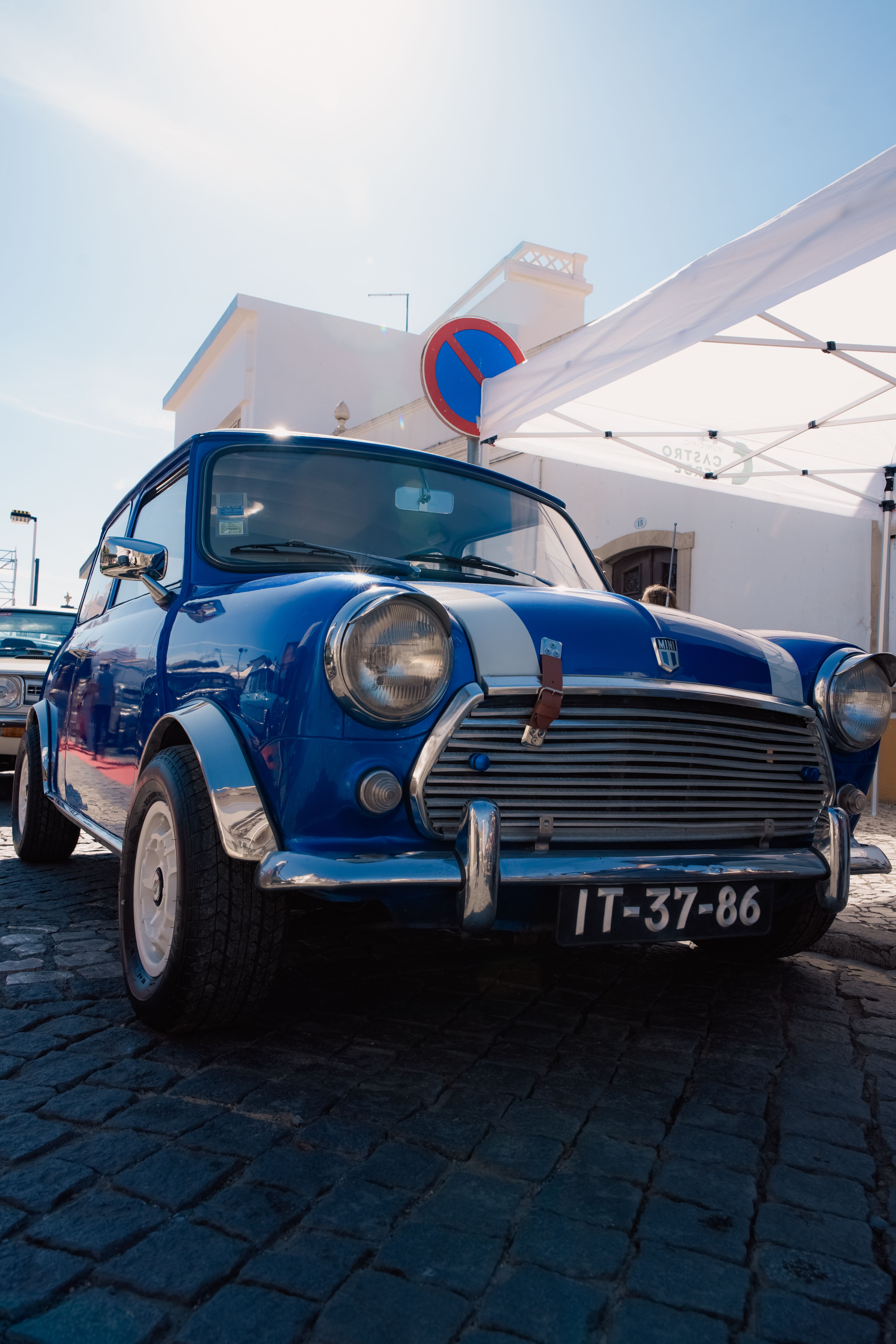 Vintage Blue Mini Cooper Parked on Cobblestones · Free Stock Photo