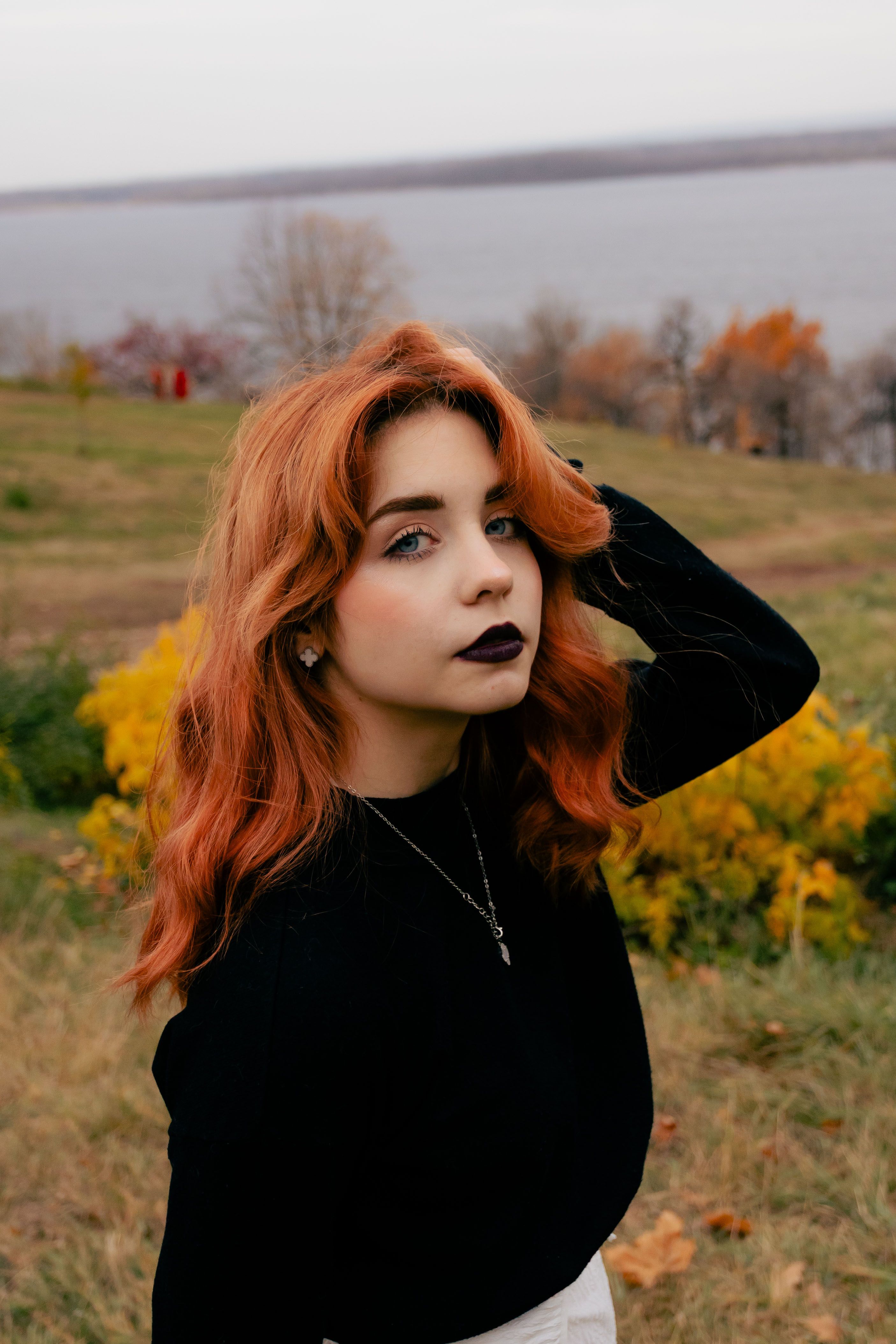 Portrait of Woman in Fall Landscape with Vibrant Hair · Free Stock Photo