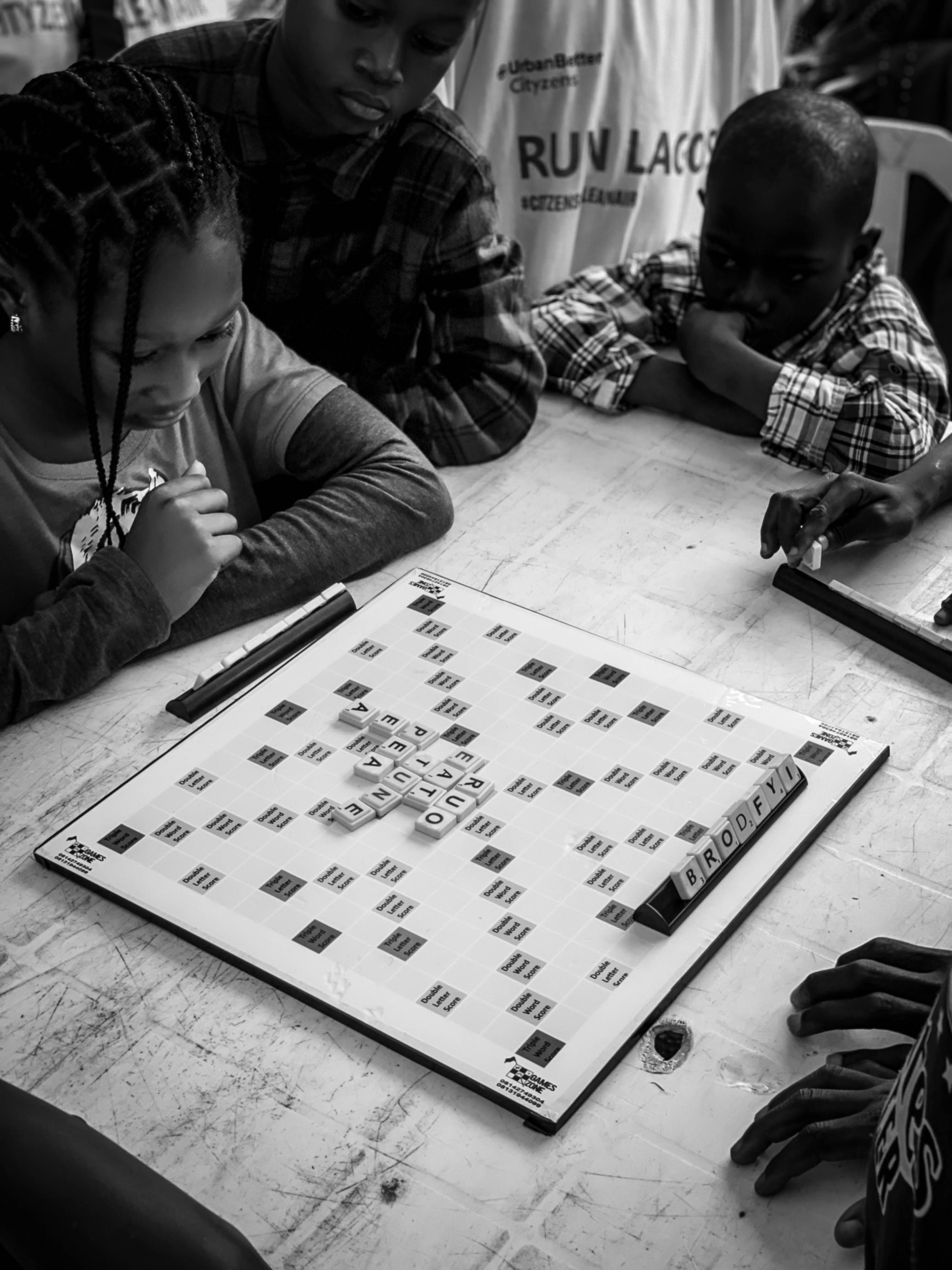 Children Playing Scrabble Game at a Table · Free Stock Photo