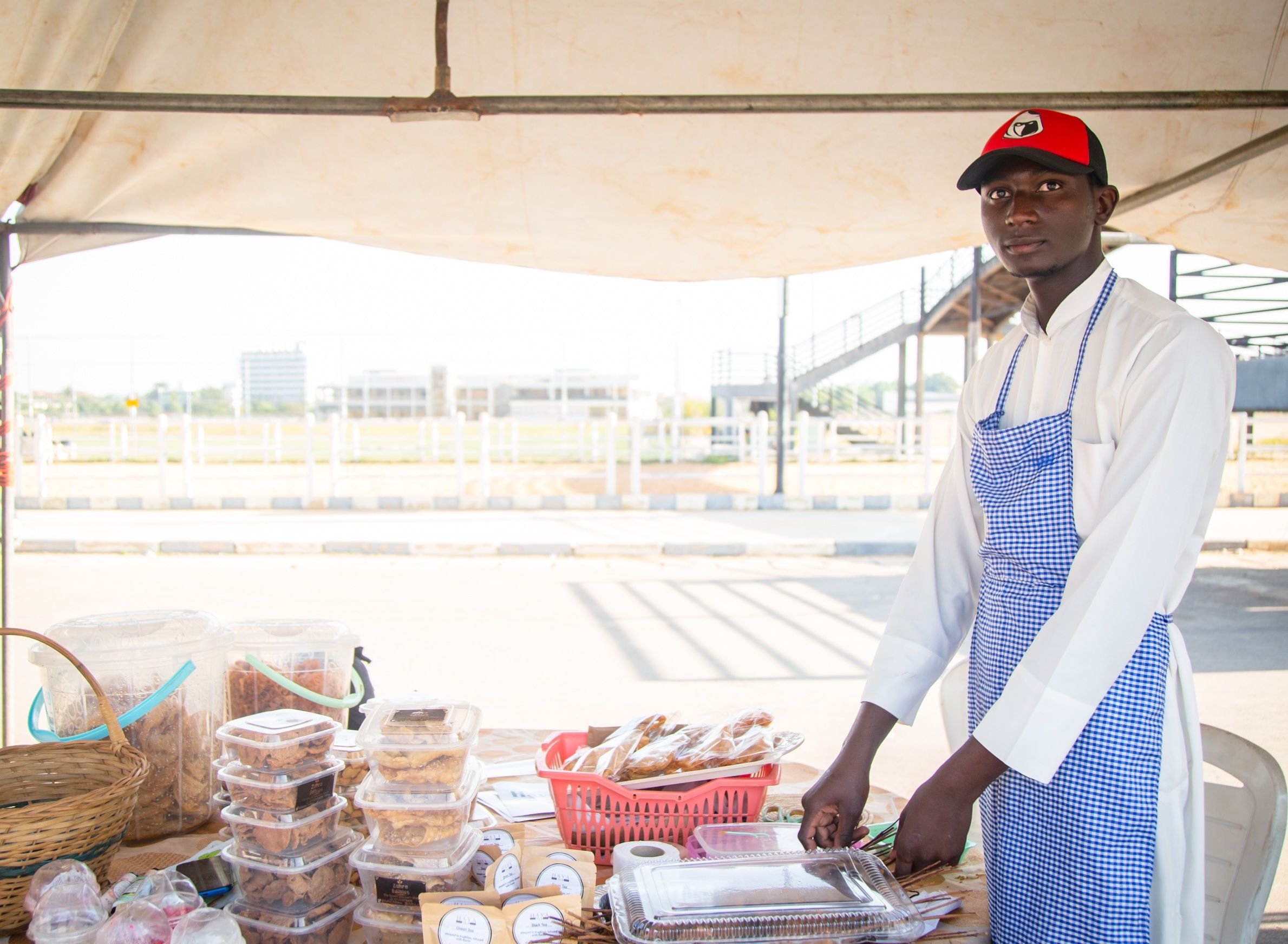 Young African Vendor in Market Stall in Kaduna · Free Stock Photo