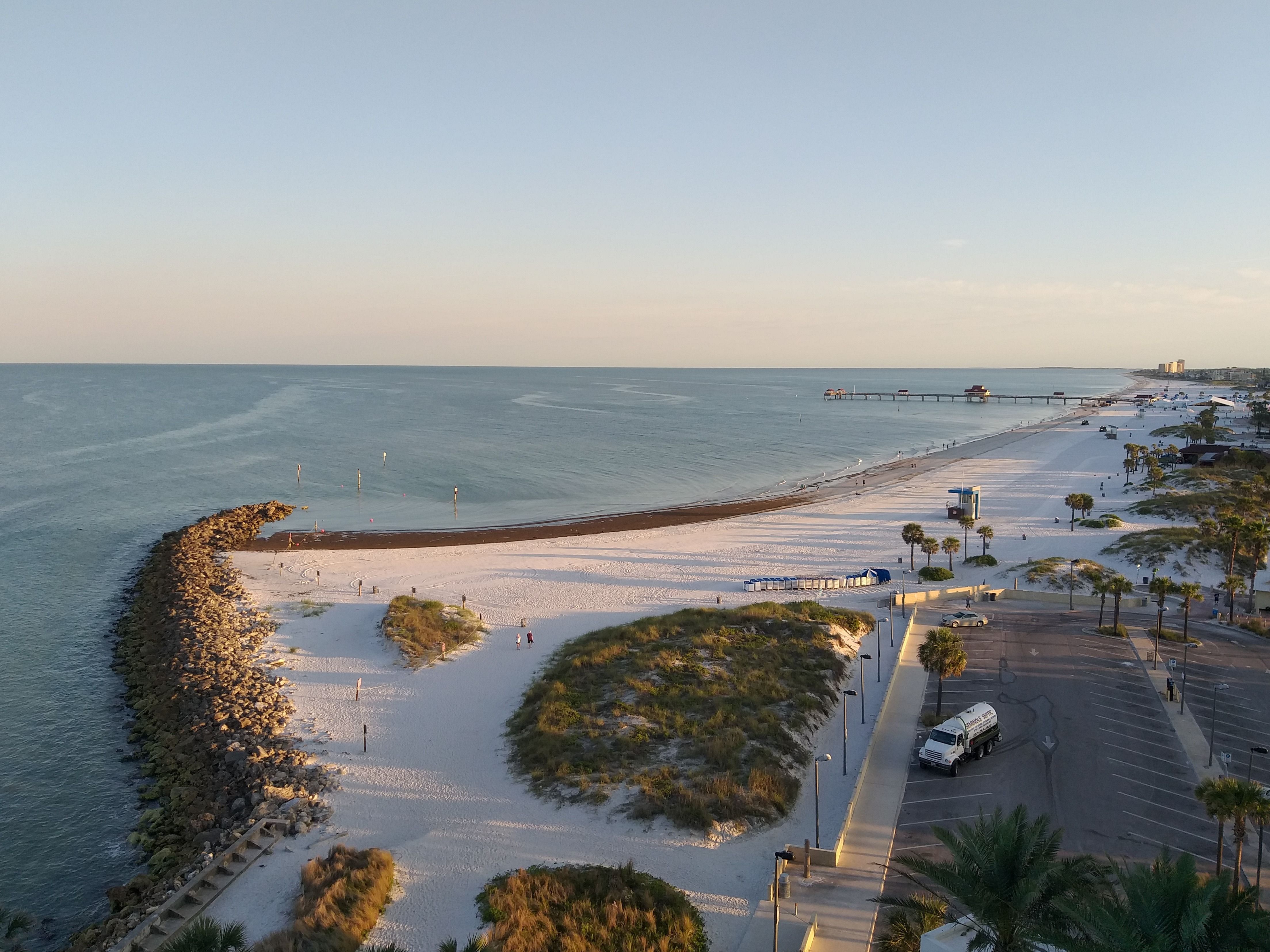 Aerial View of Sandy Beach and Pier at Sunset · Free Stock Photo