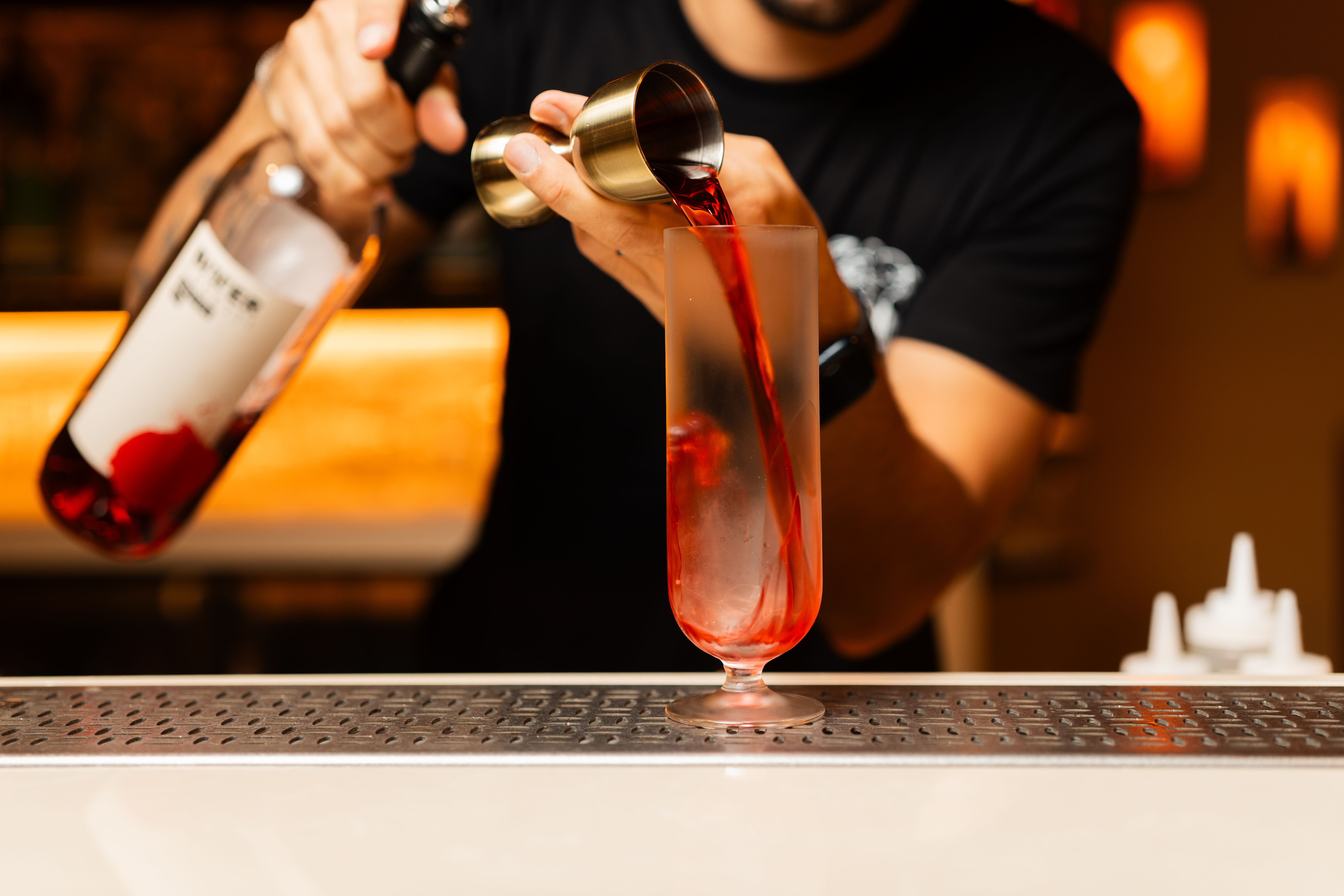 Bartender Pouring Red Cocktail at Bar · Free Stock Photo