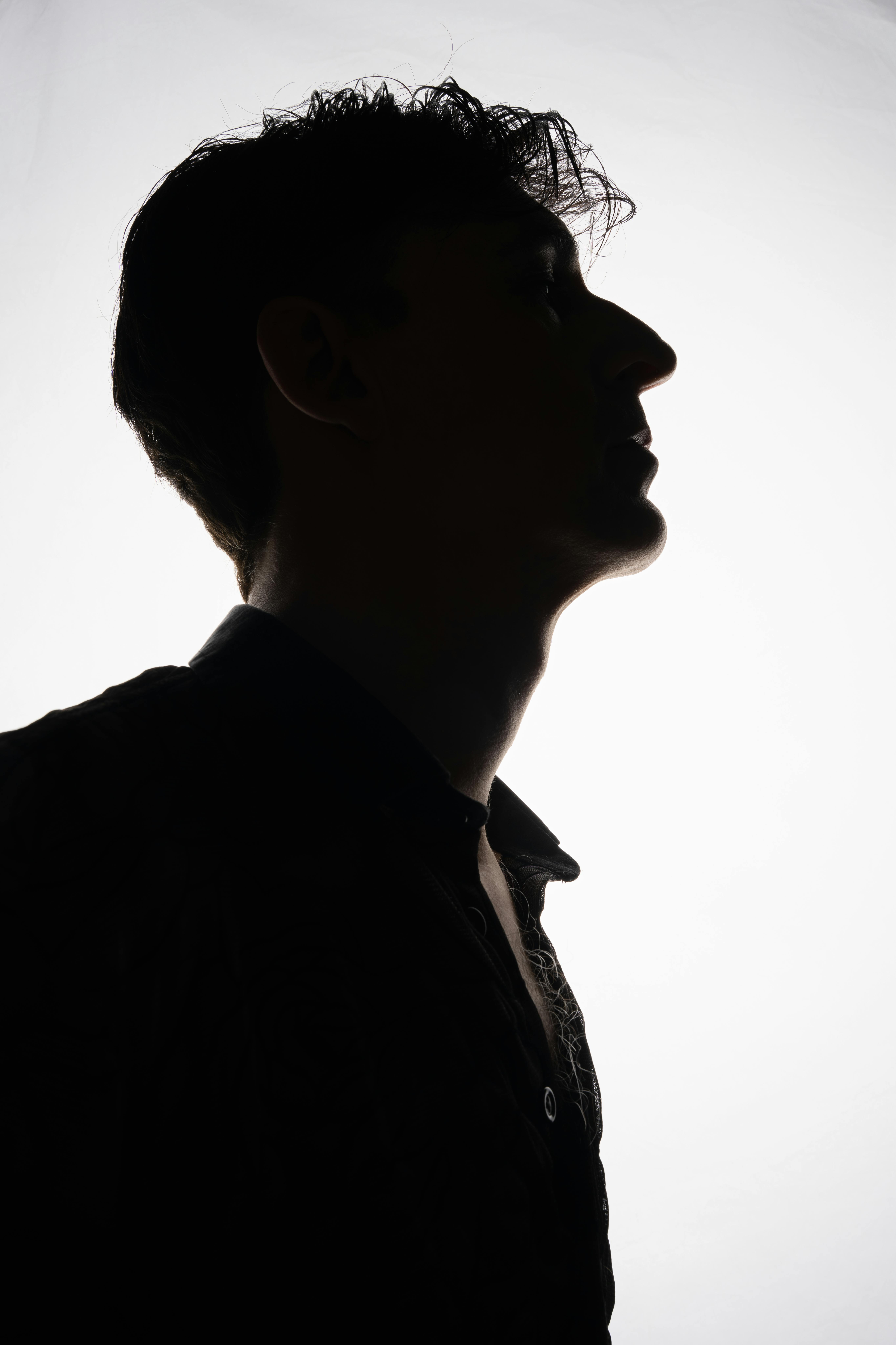Dramatic Silhouette Portrait Against White Light · Free Stock Photo