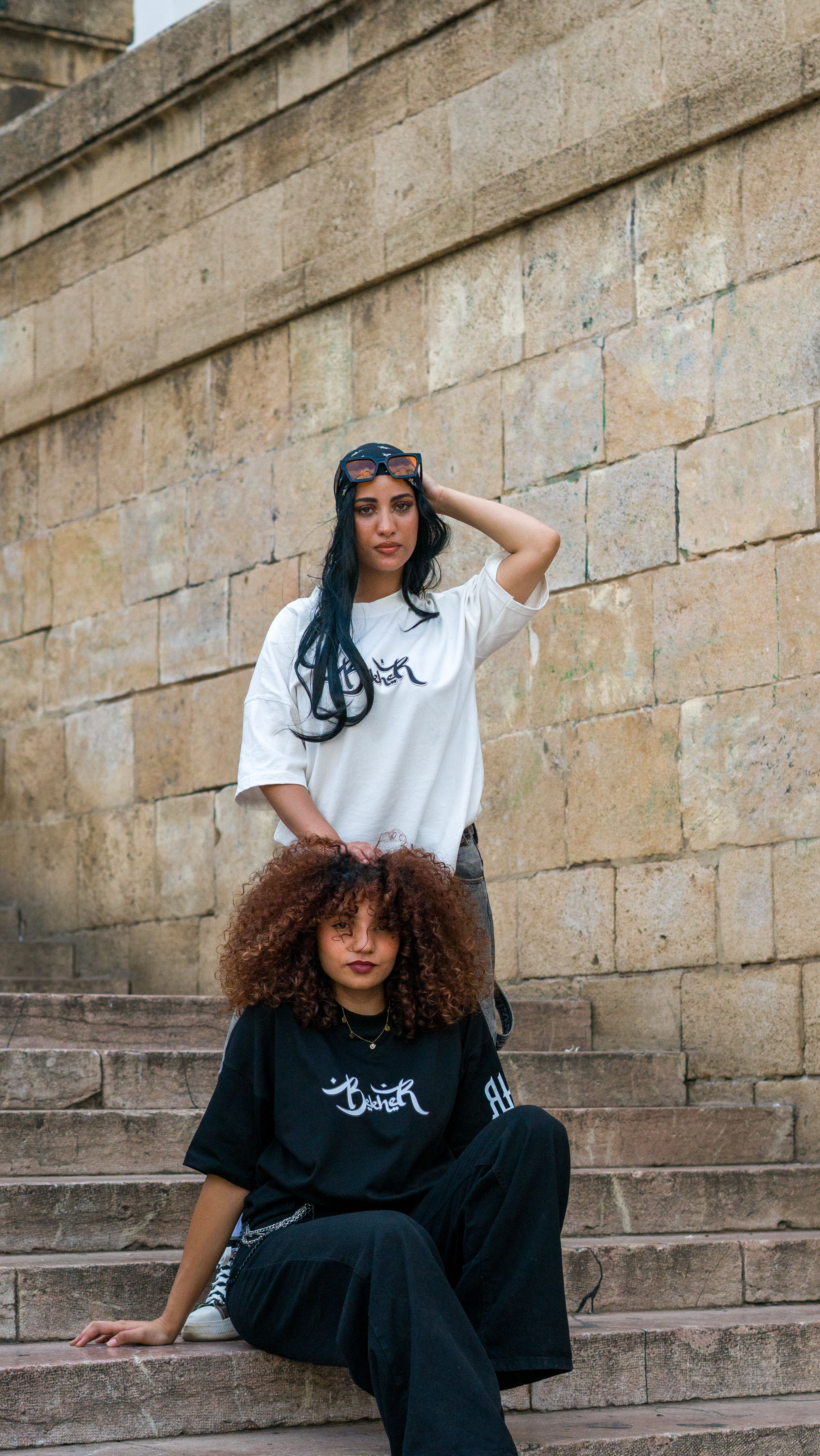 Fashionable Portrait of Two Women on Stone Steps · Free Stock Photo