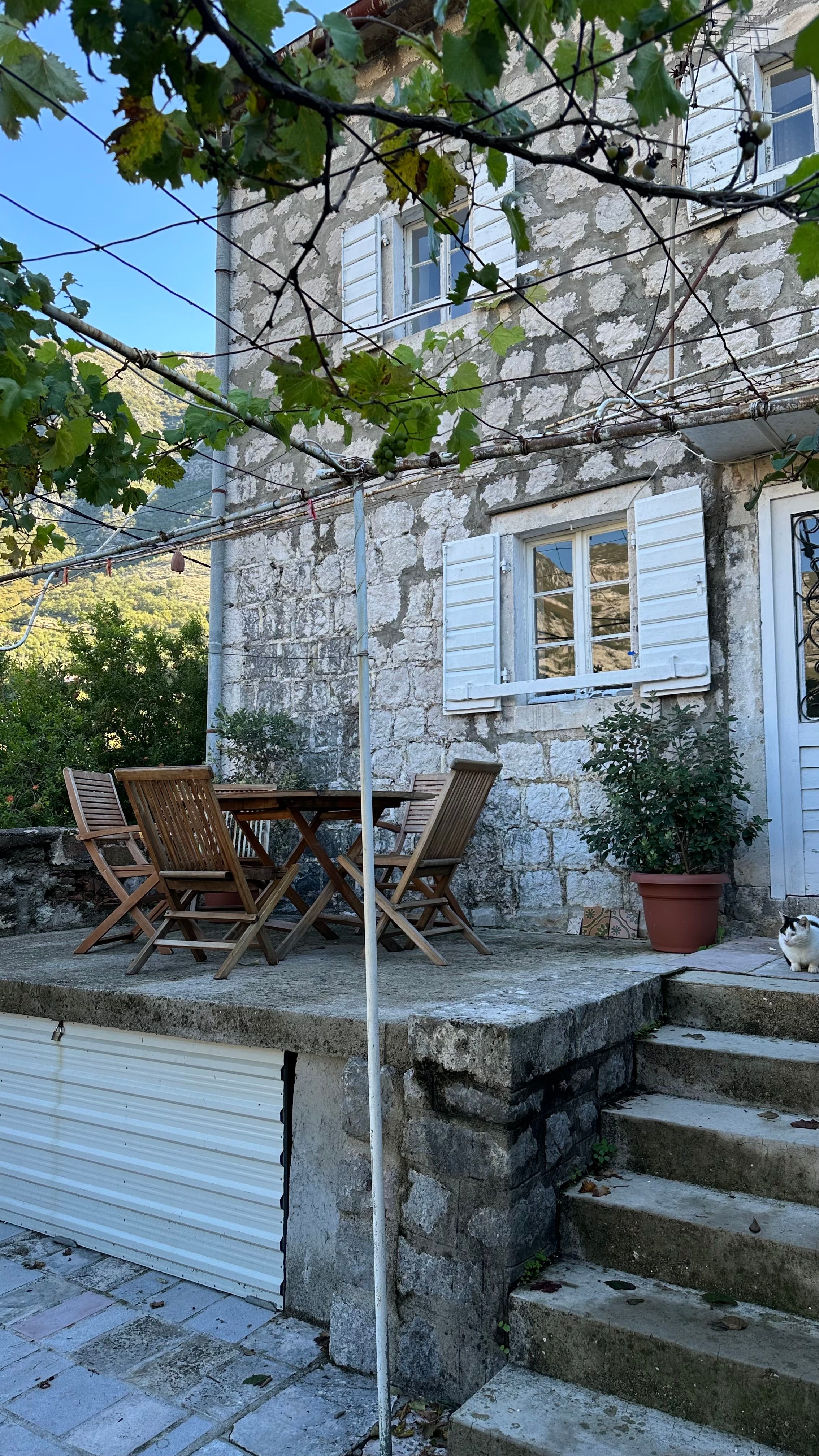 Charming Stone House with Rustic Outdoor Seating · Free Stock Photo