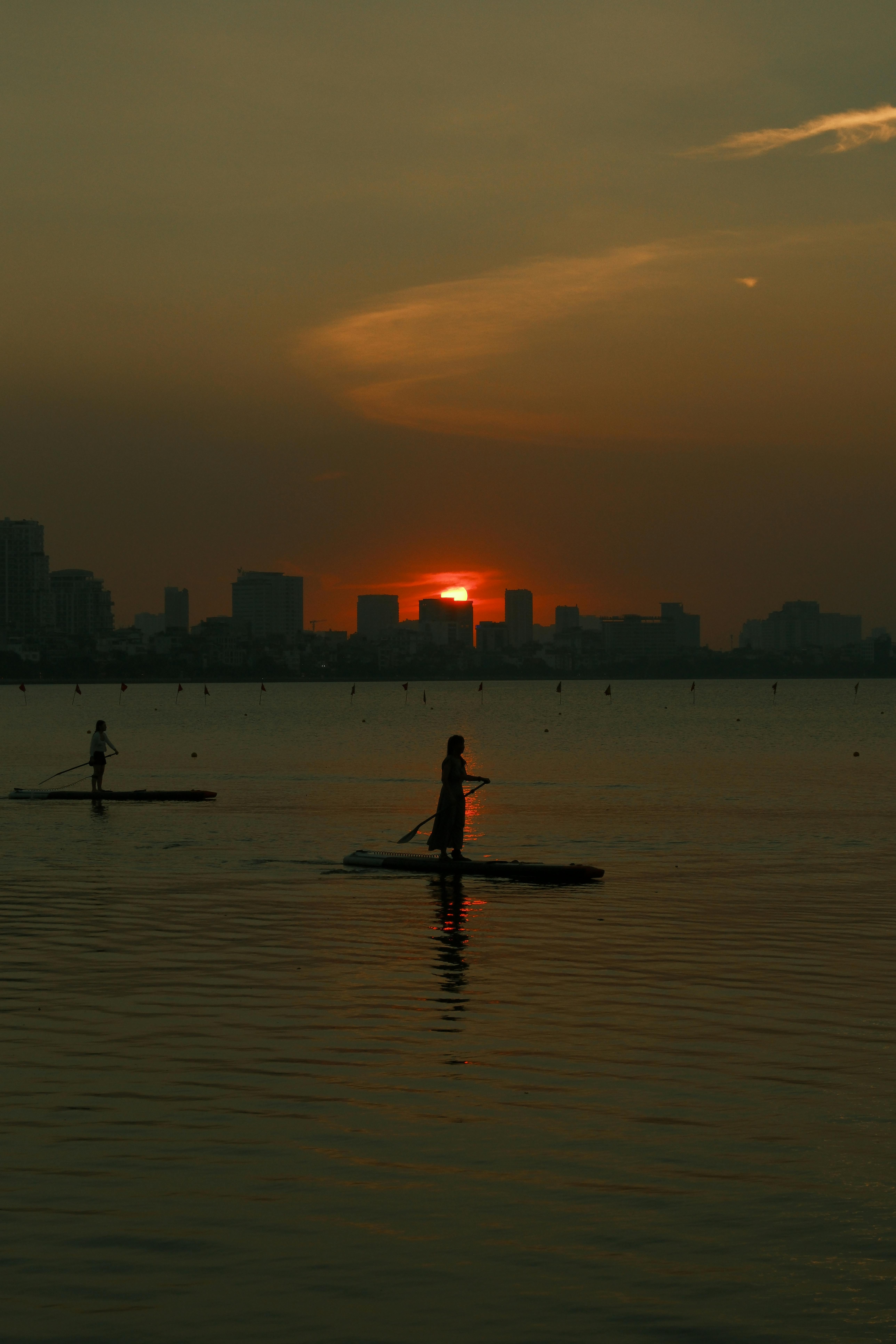 Silhouetted Paddleboarding at Sunset in Jamaica · Free Stock Photo