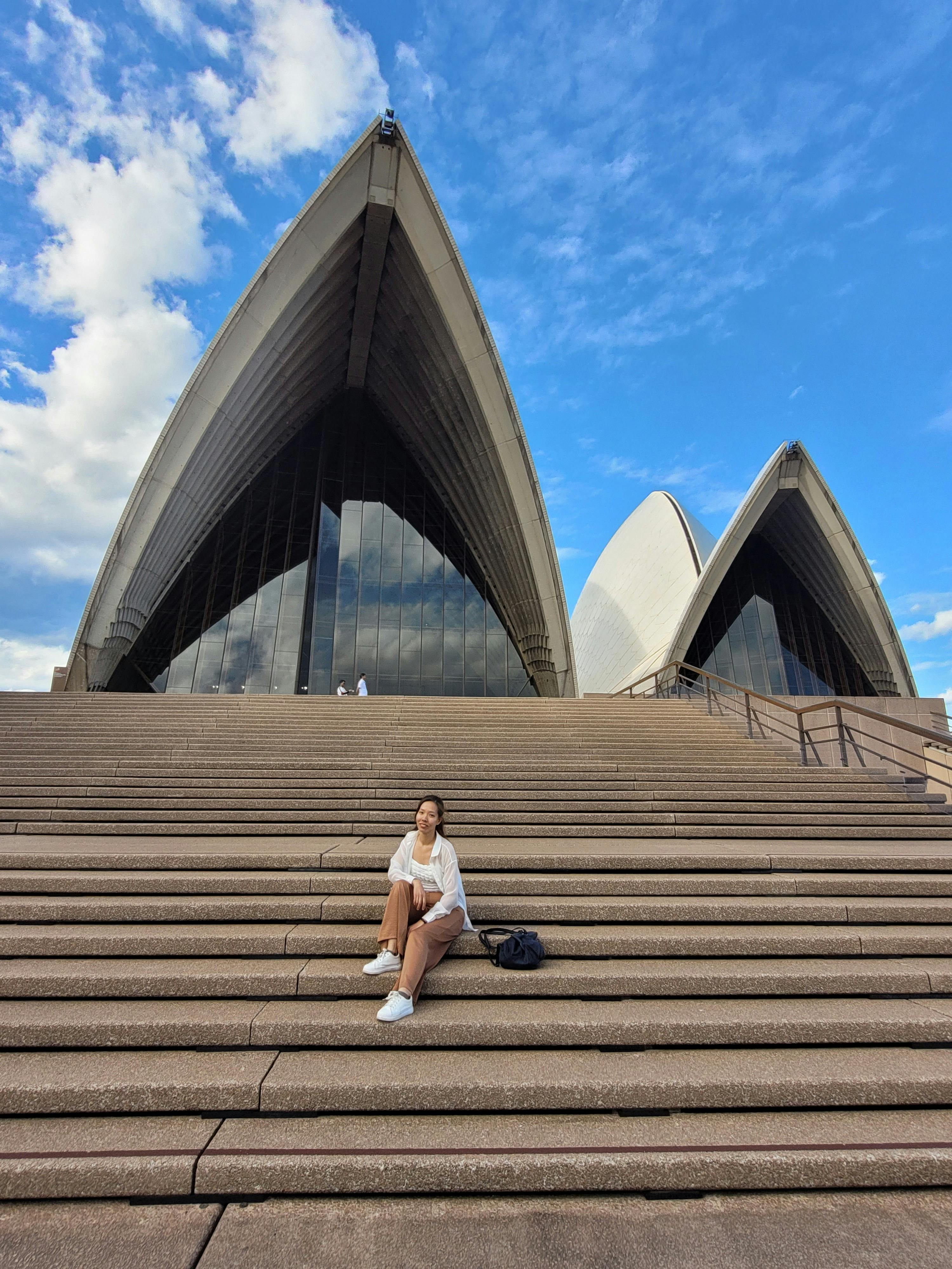 Woman Sitting on Sydney Opera House Steps · Free Stock Photo