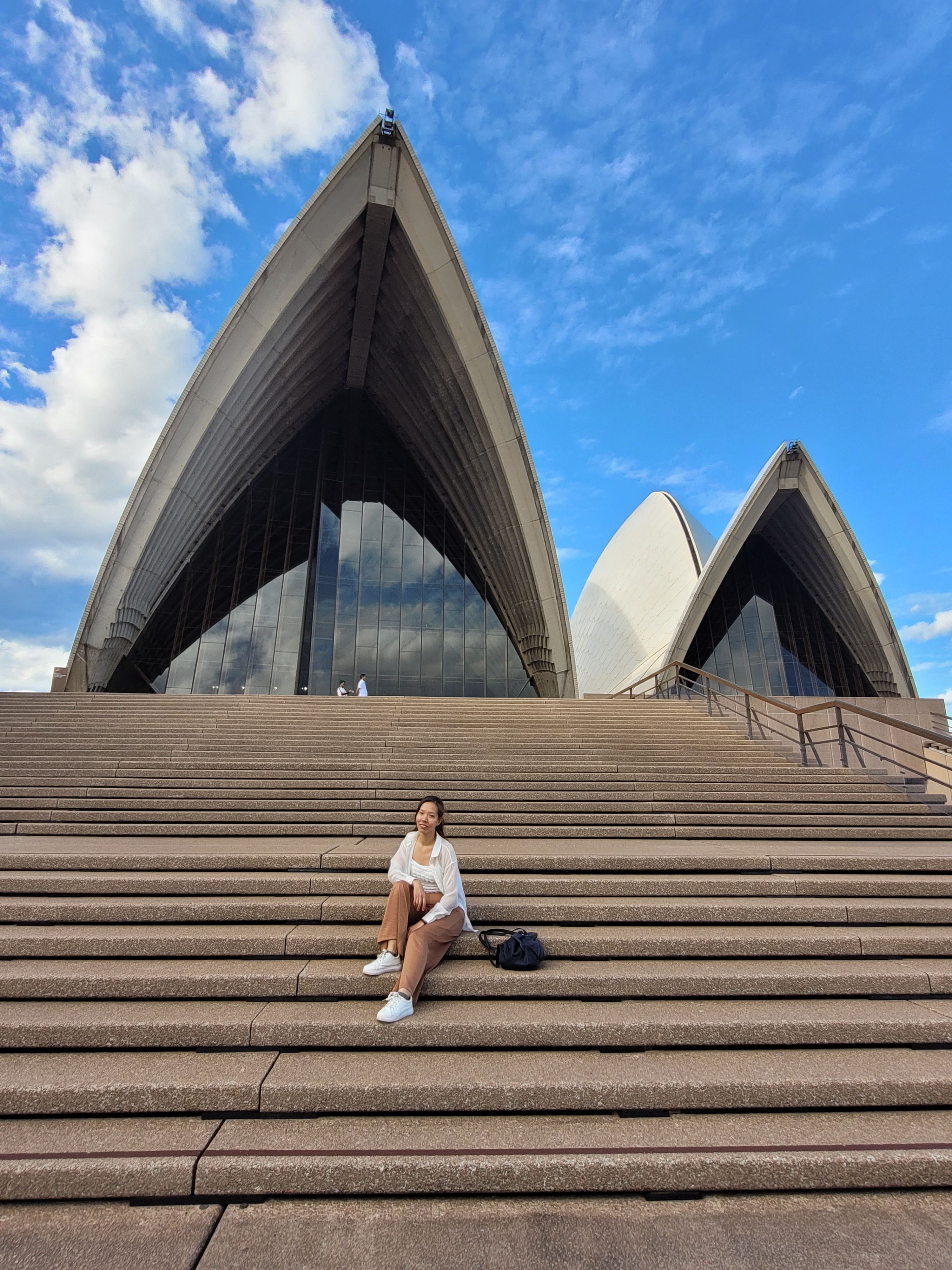 Woman Sitting on Sydney Opera House Steps · Free Stock Photo