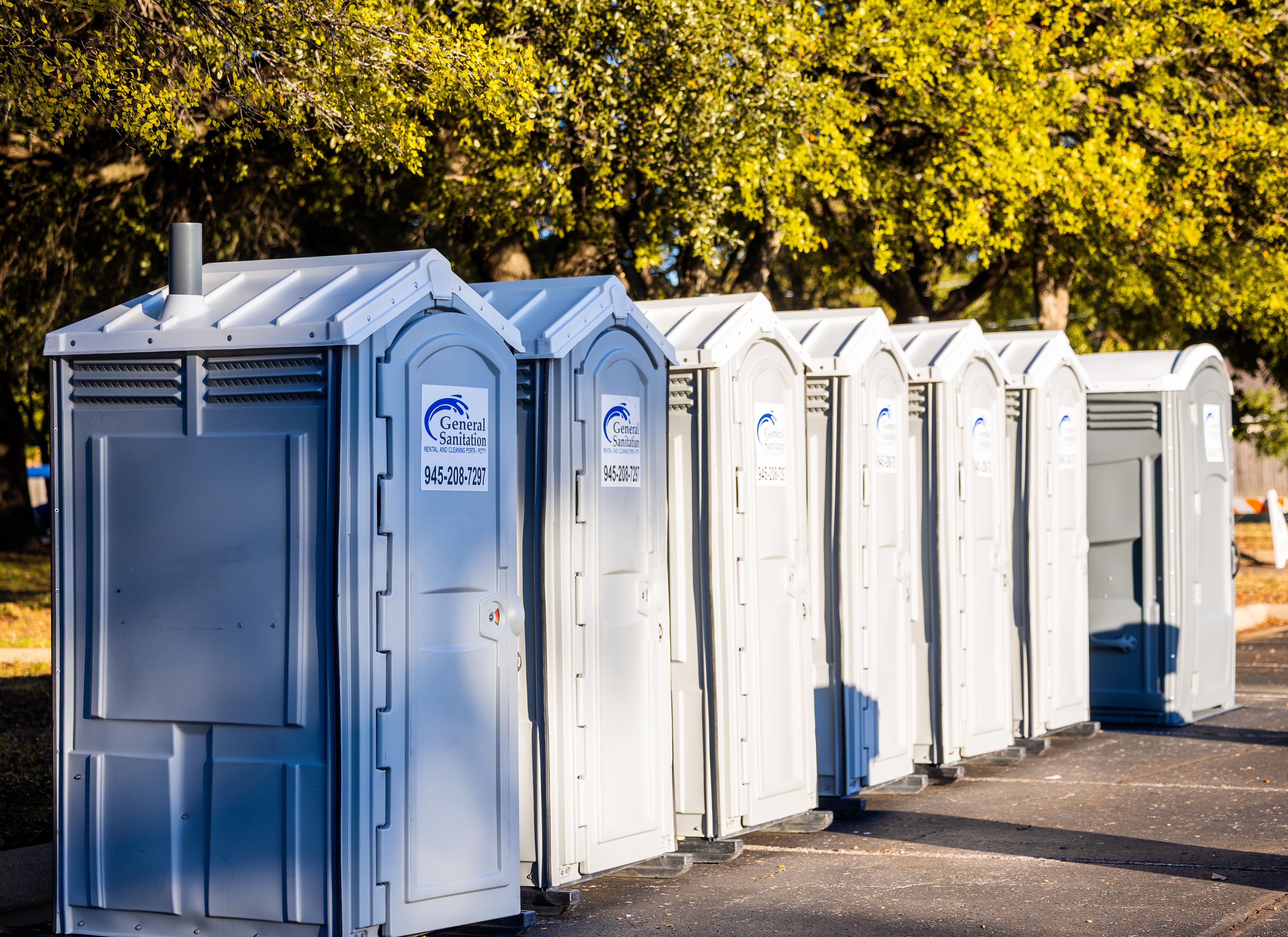 Row of Portable Toilets in Outdoor Setting · Free Stock Photo