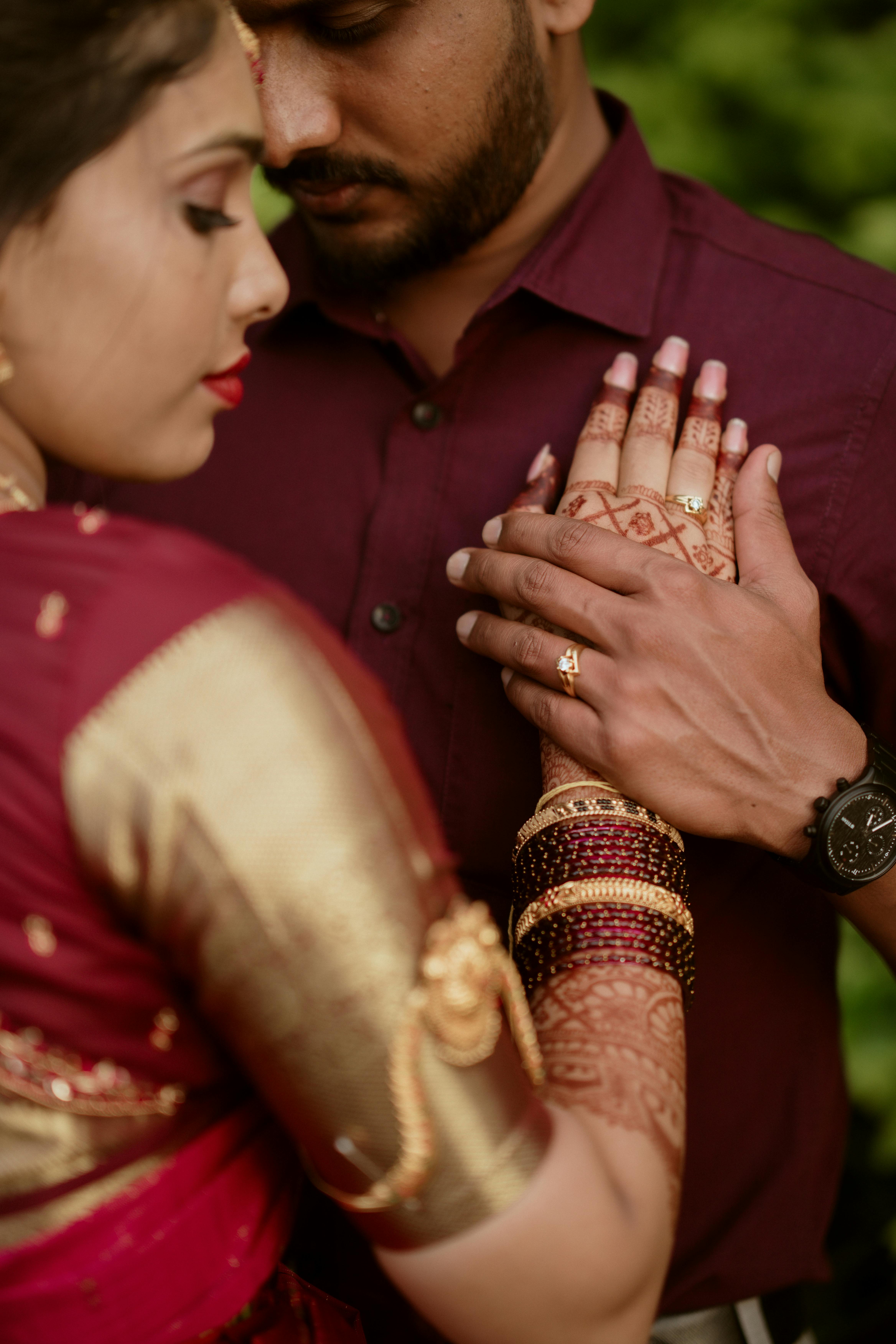 Couple Embracing with Henna Decorated Hands · Free Stock Photo
