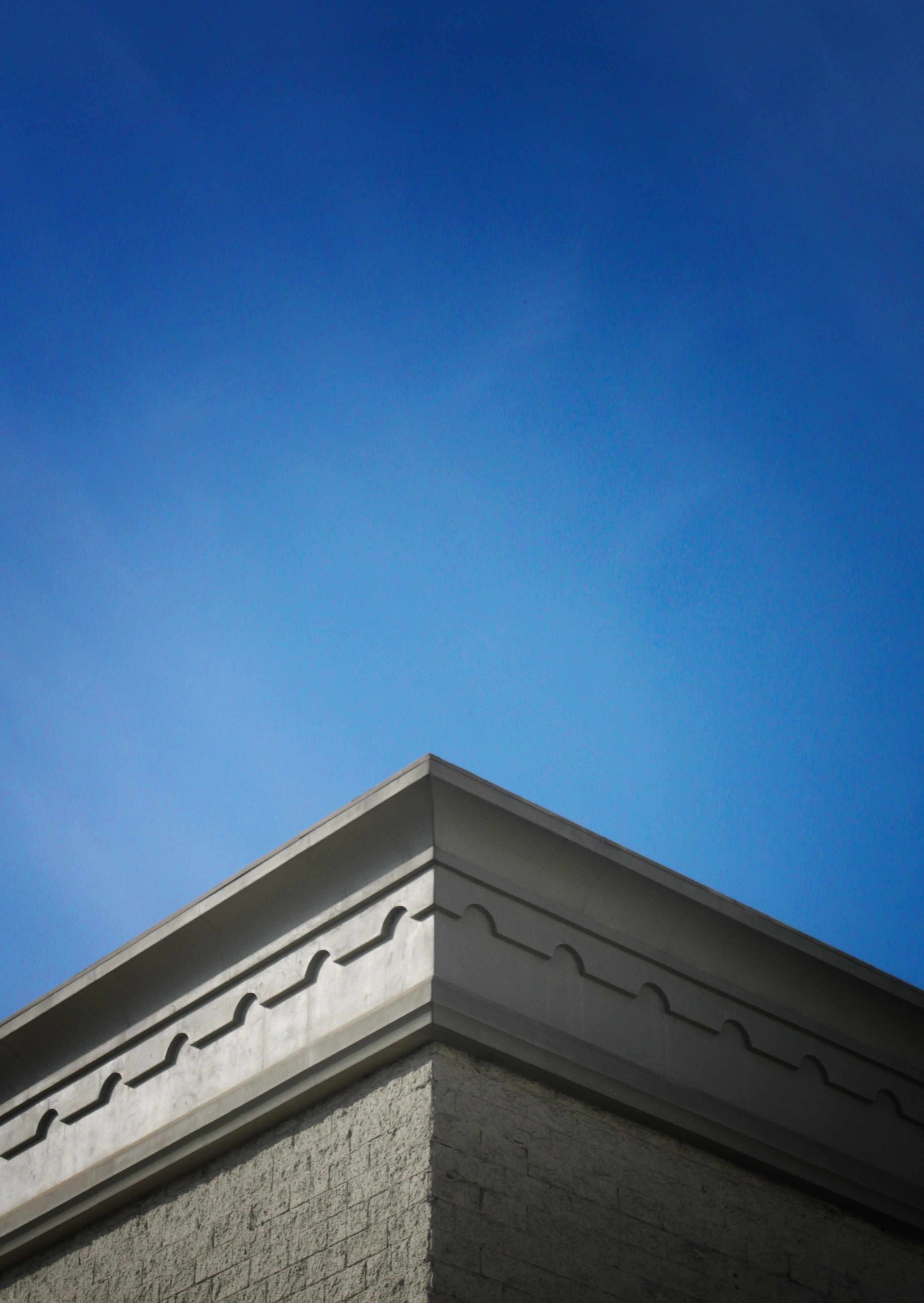 Architectural Roof Corner Against Blue Sky · Free Stock Photo