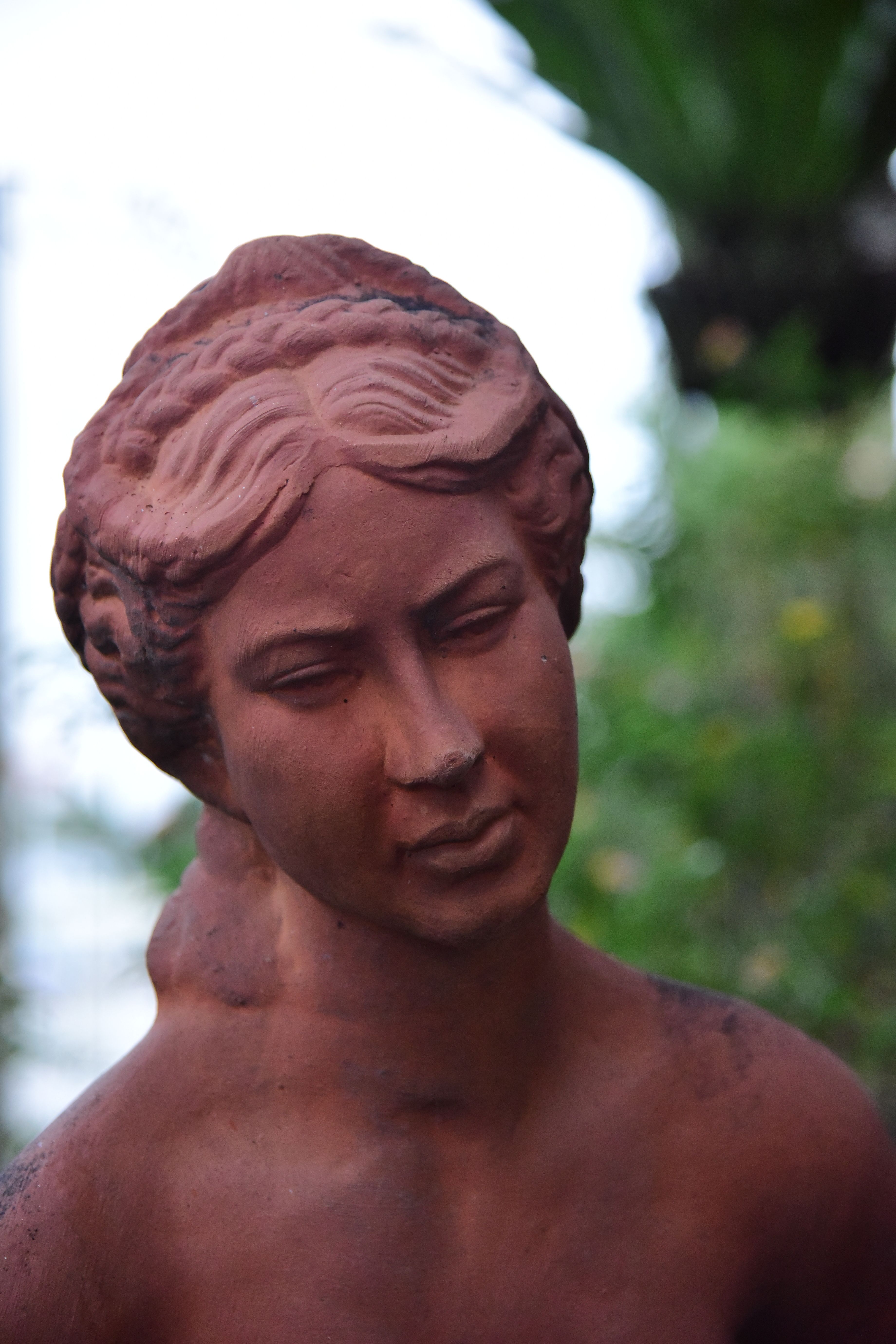 Classical Woman Sculpture in Garden Setting · Free Stock Photo