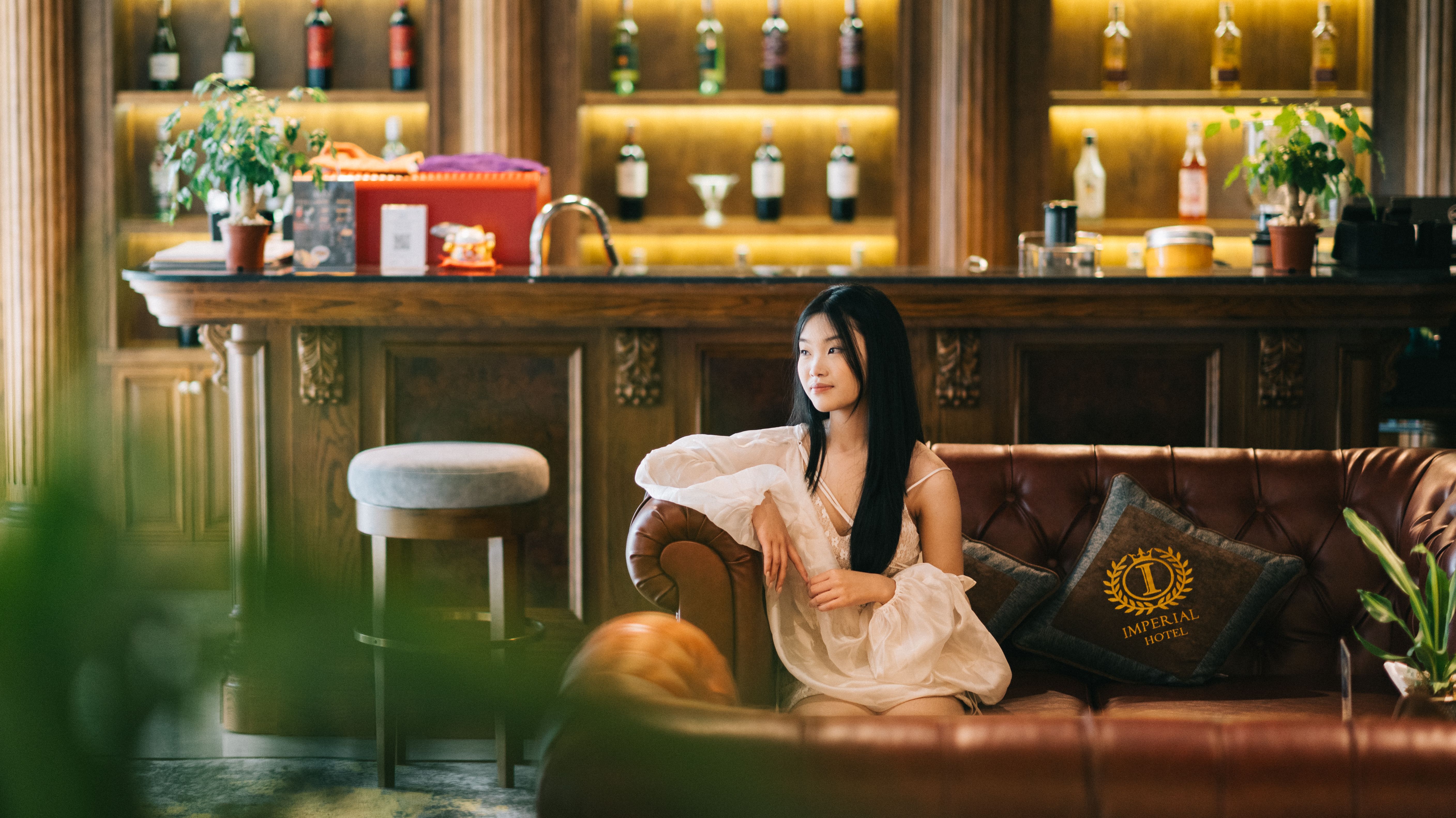 Elegant Woman Relaxing in Vietnamese Hotel Lounge · Free Stock Photo