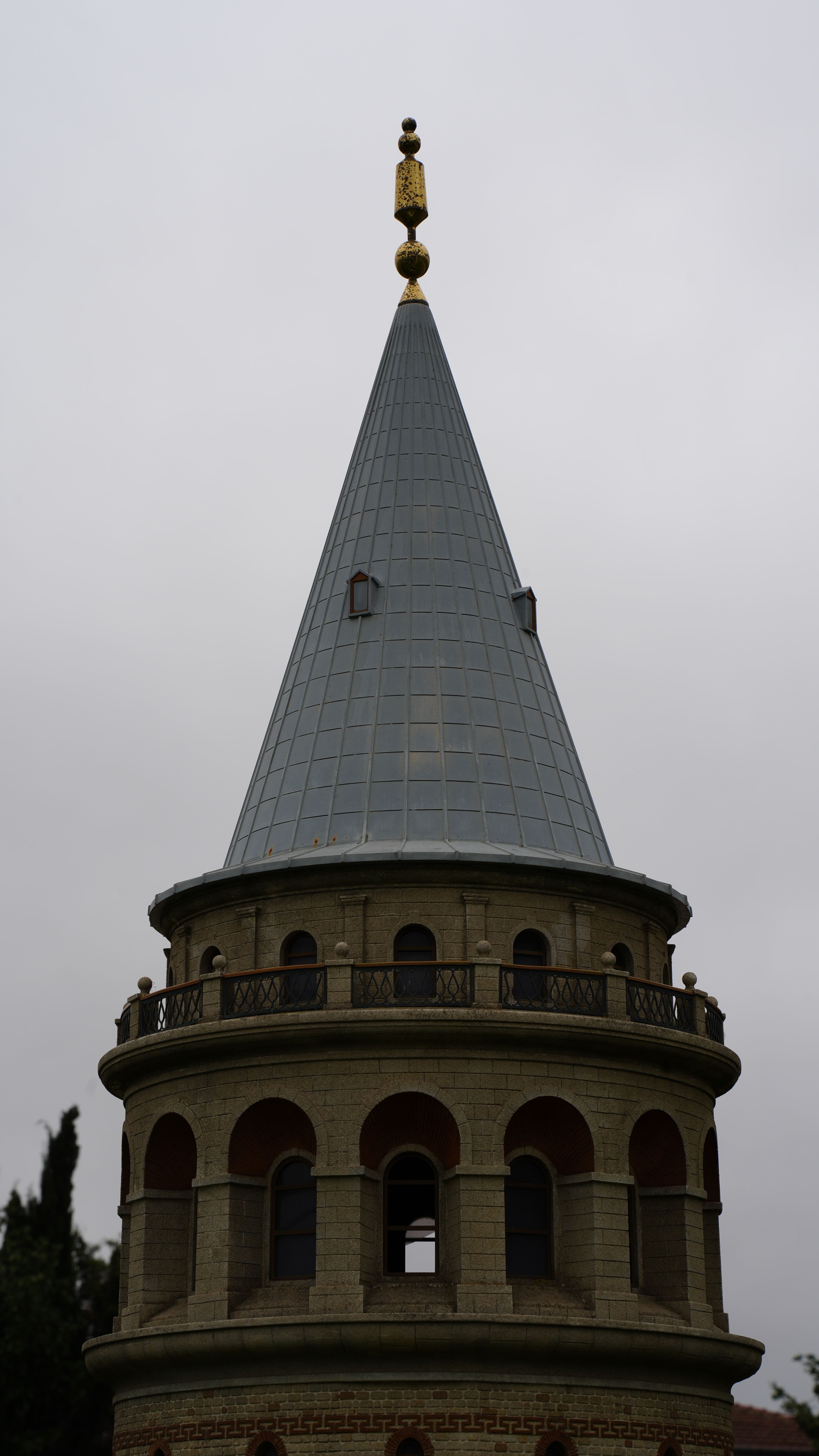 Historic Tower with Conical Roof on Cloudy Day · Free Stock Photo