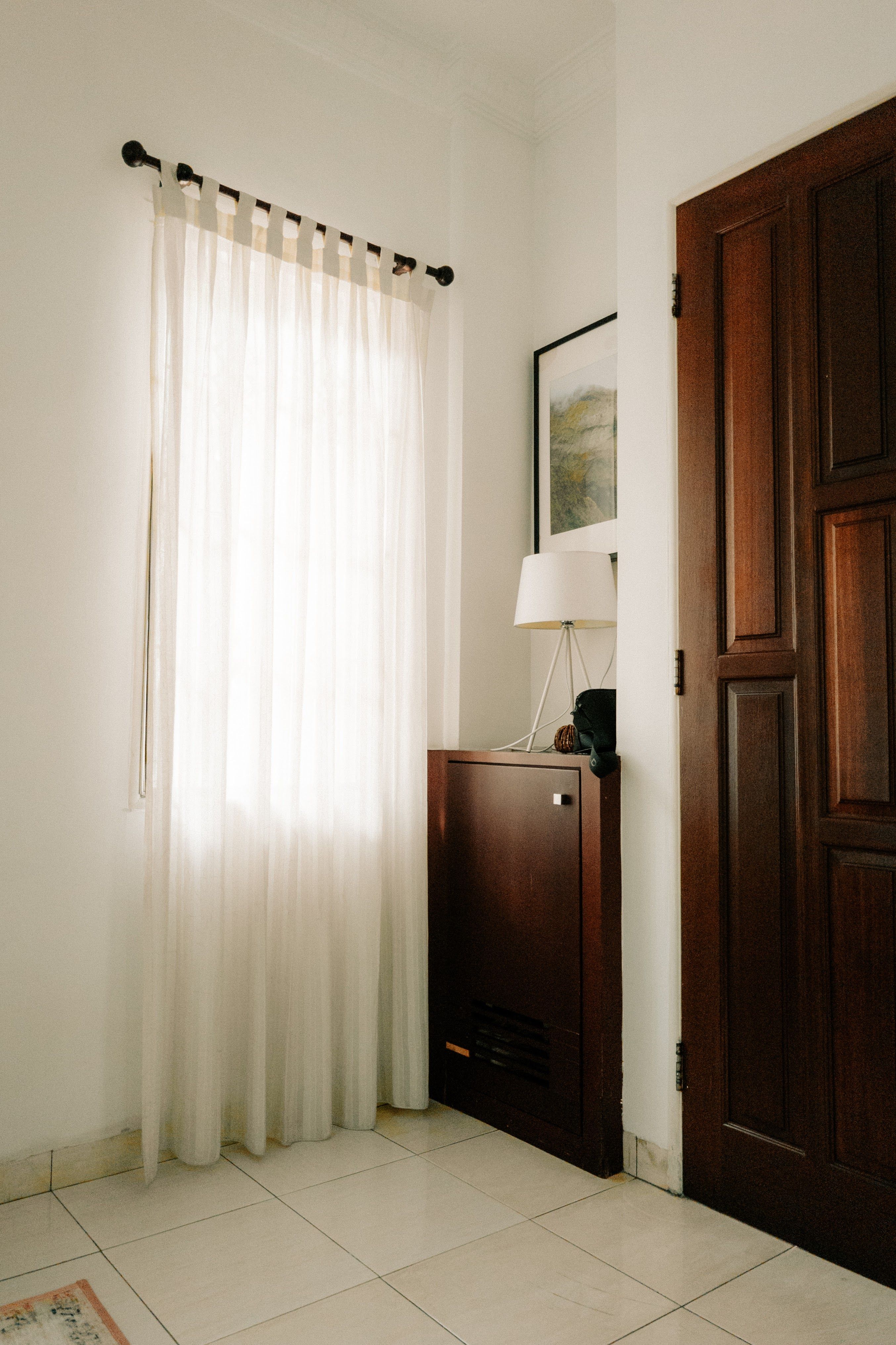 Minimalist Home Corner with Wooden Door and Lamp · Free Stock Photo