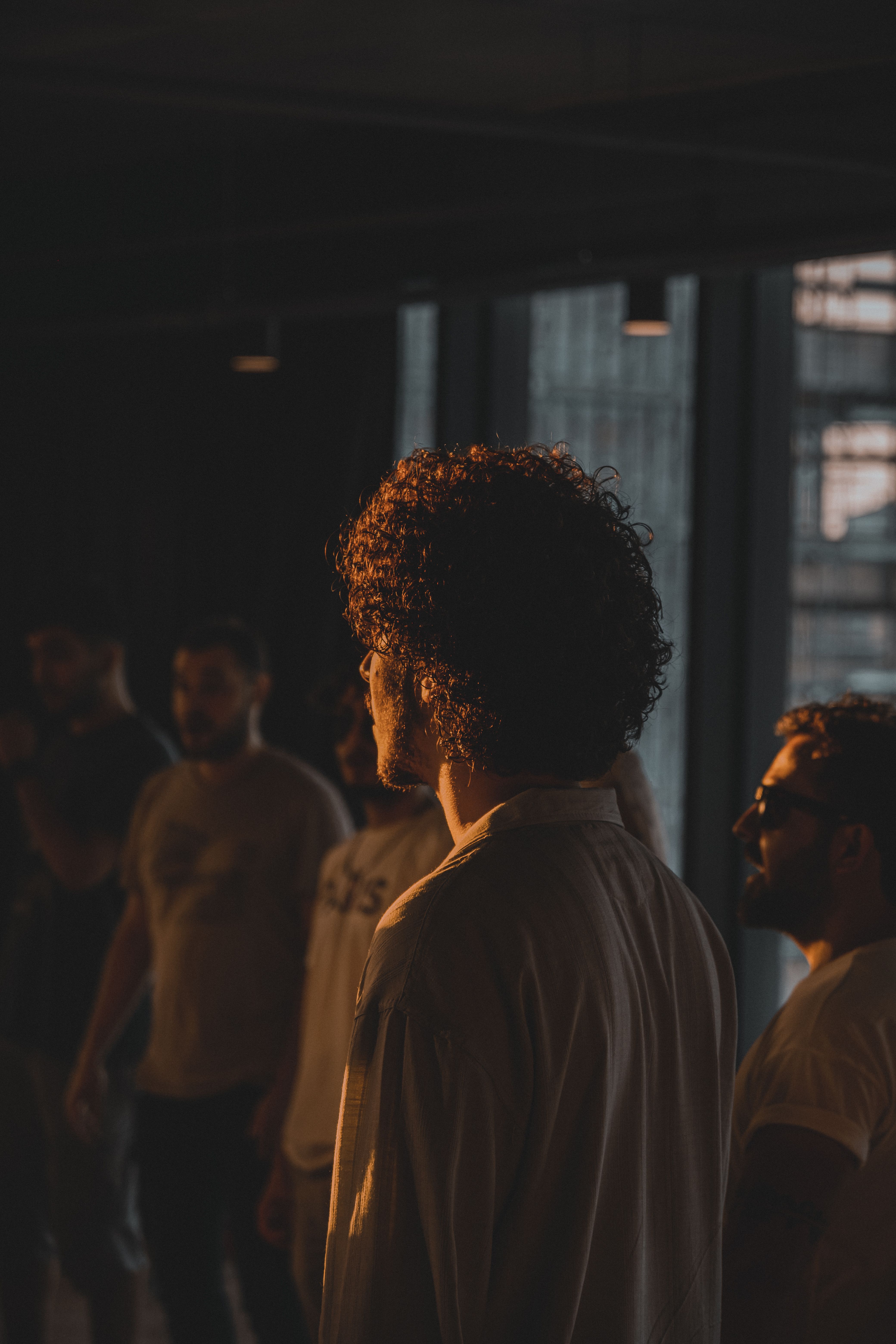 Group of People in Warm Indoor Lighting · Free Stock Photo
