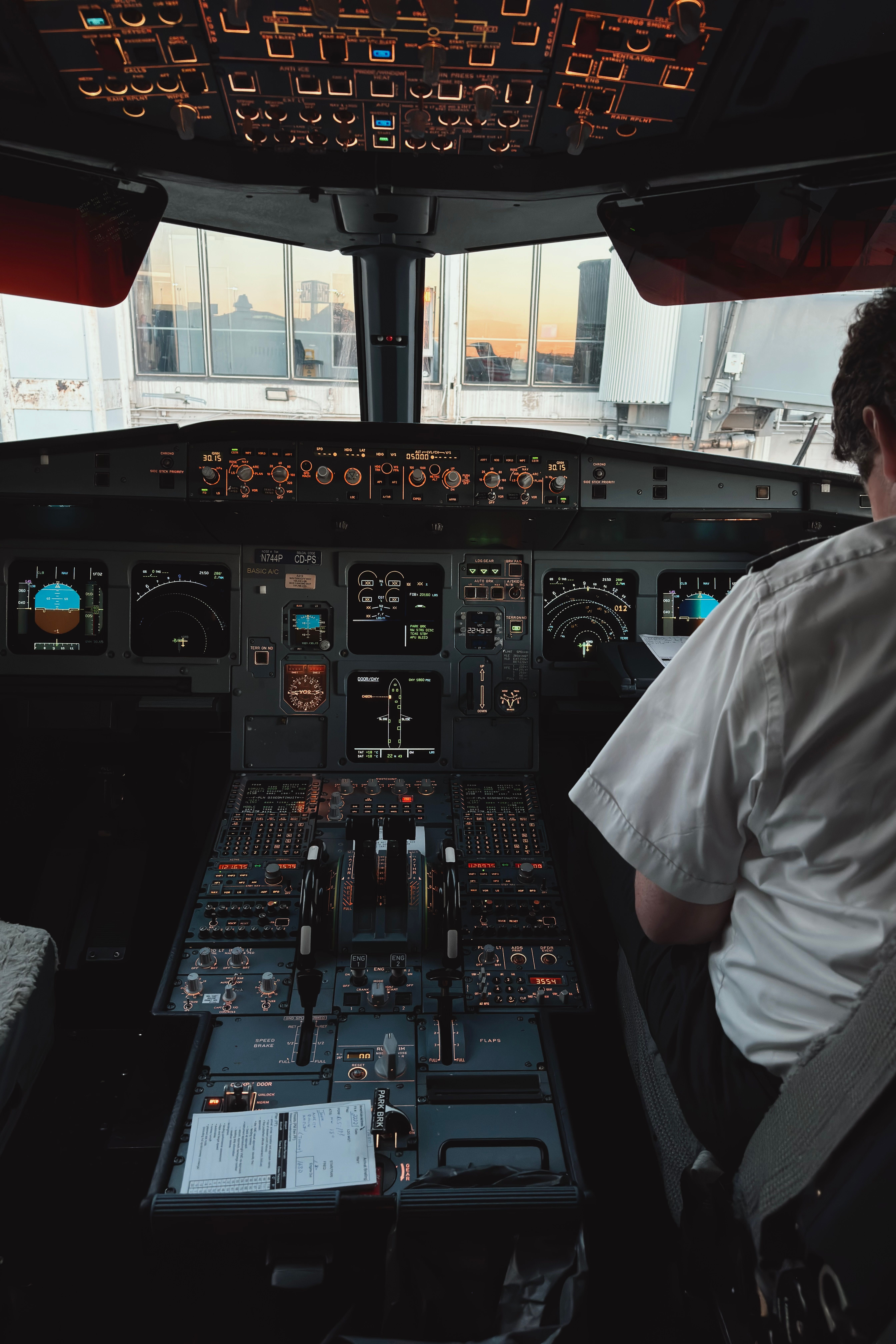 Airplane Cockpit with Pilot at Sunset · Free Stock Photo
