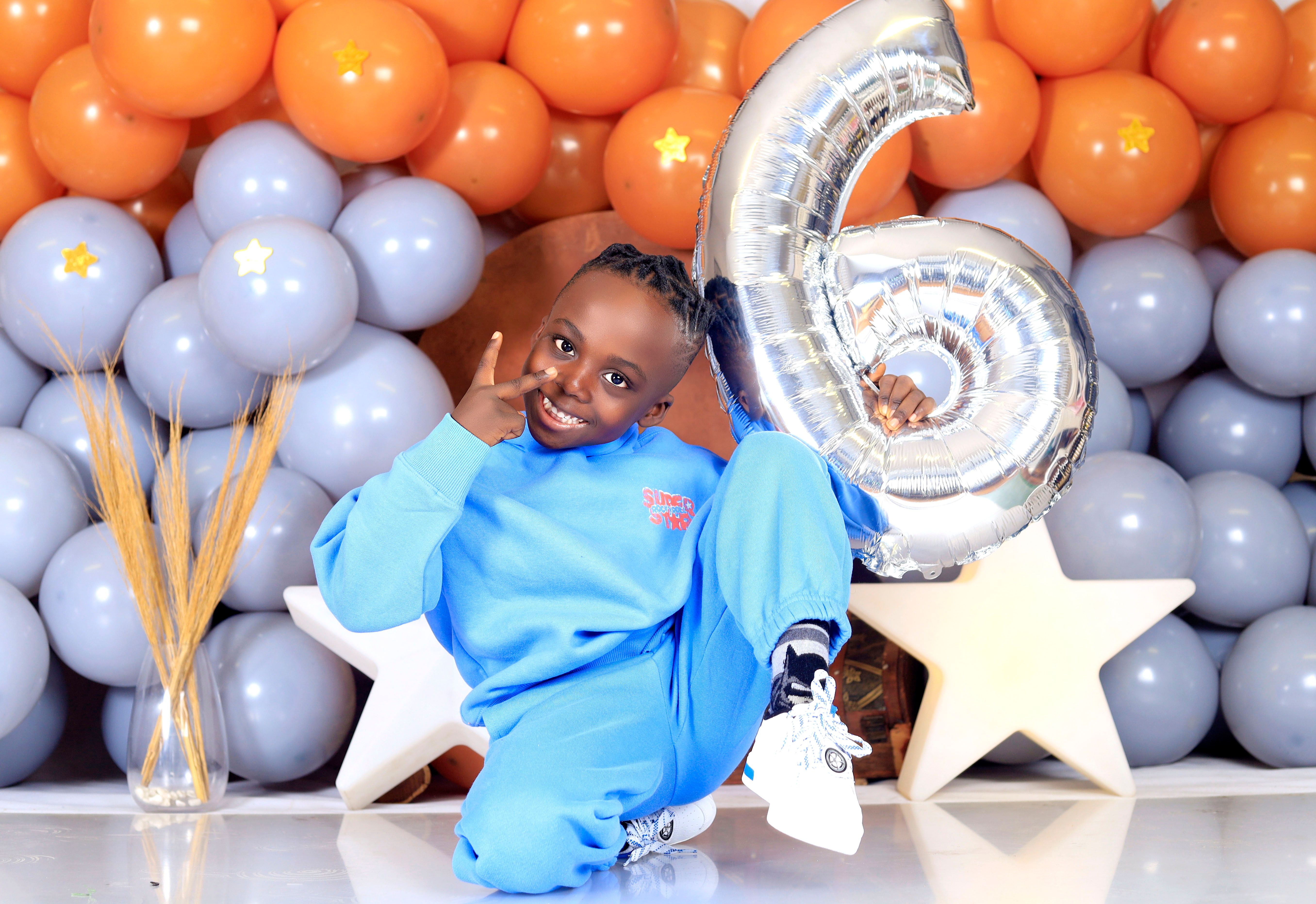 Child Celebrating Sixth Birthday with Balloons · Free Stock Photo