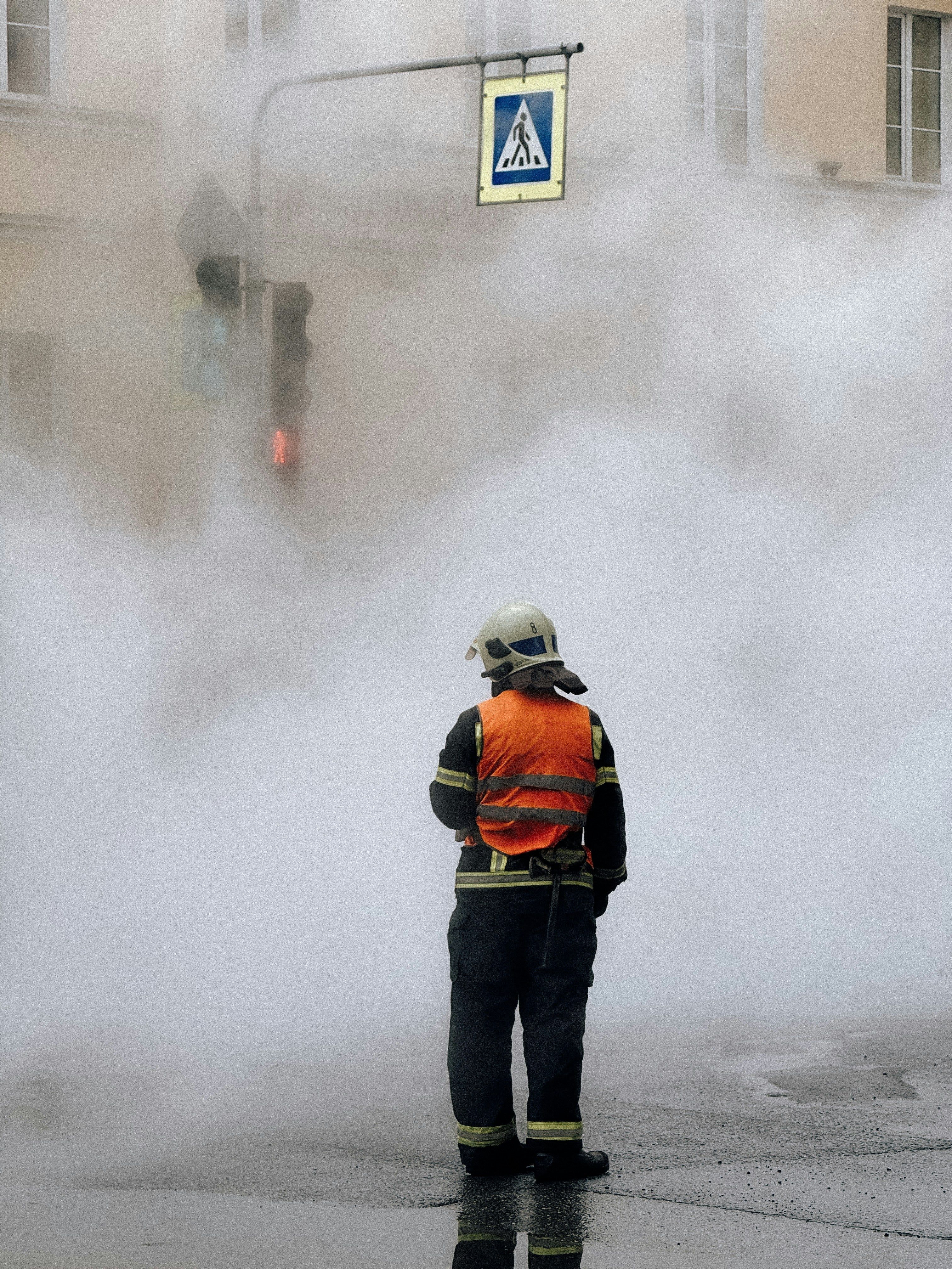 Firefighter in Smoke at City Crosswalk · Free Stock Photo