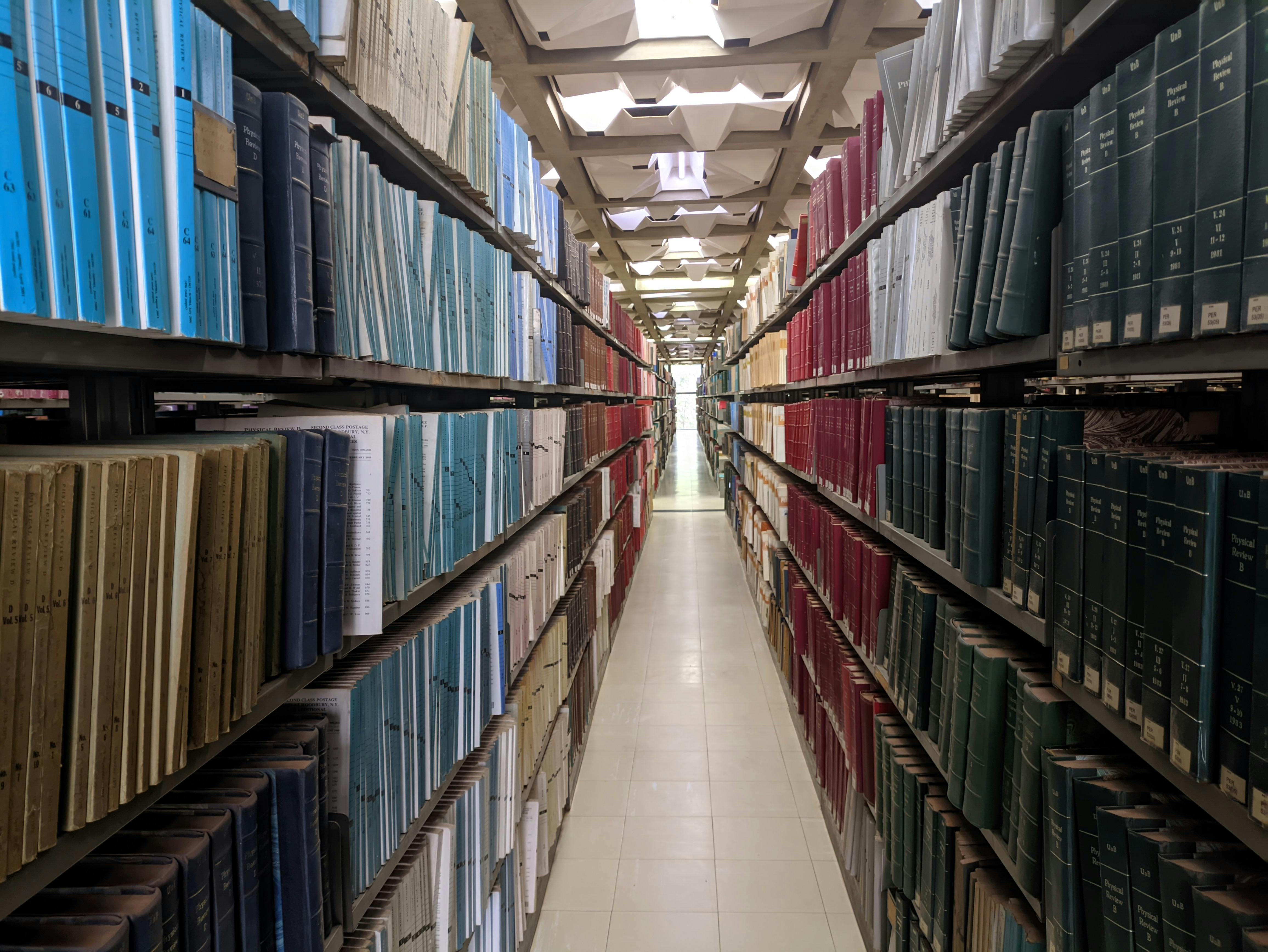 Endless Library Aisle with Colorful Books · Free Stock Photo