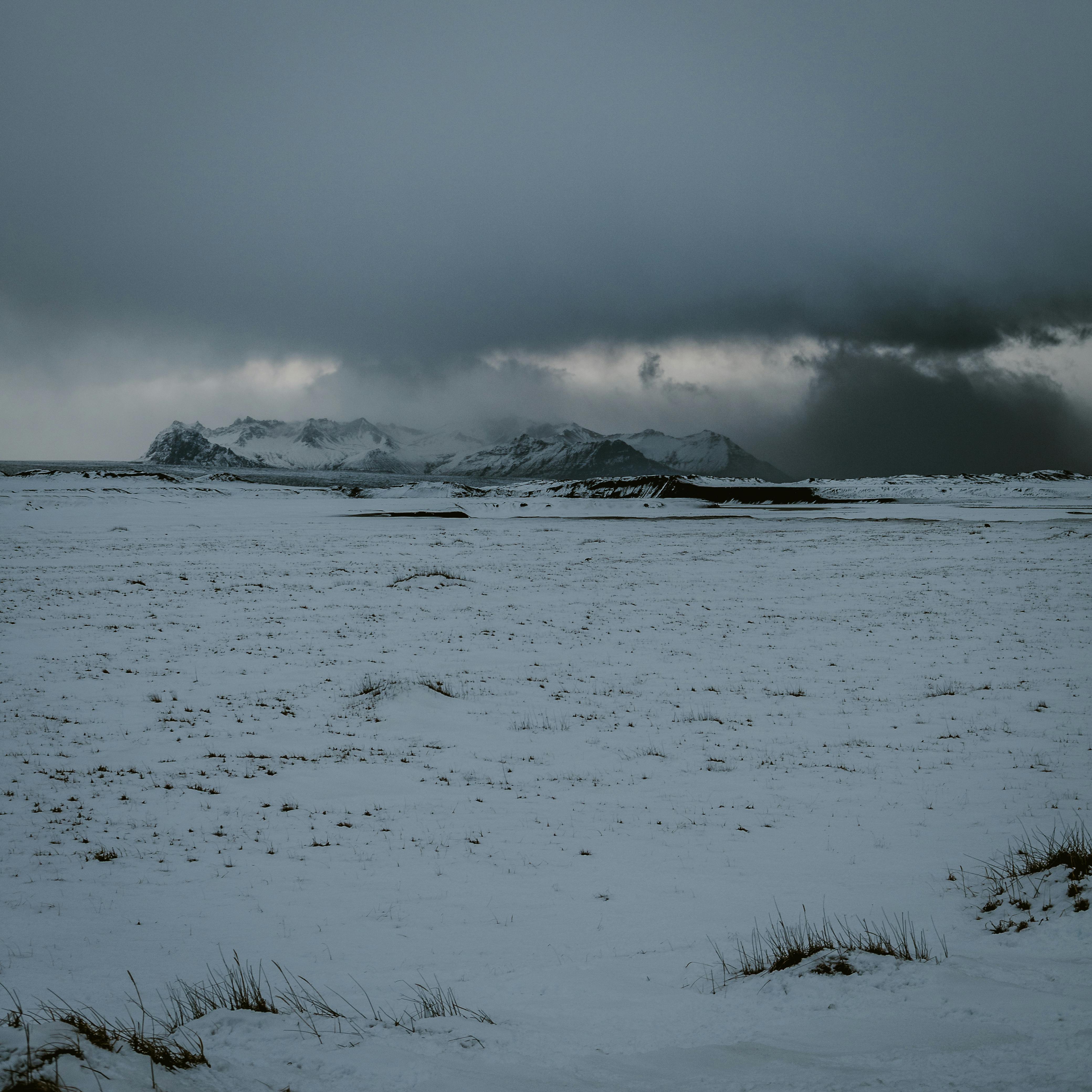 Dramatic Snowy Landscape with Stormy Skies · Free Stock Photo