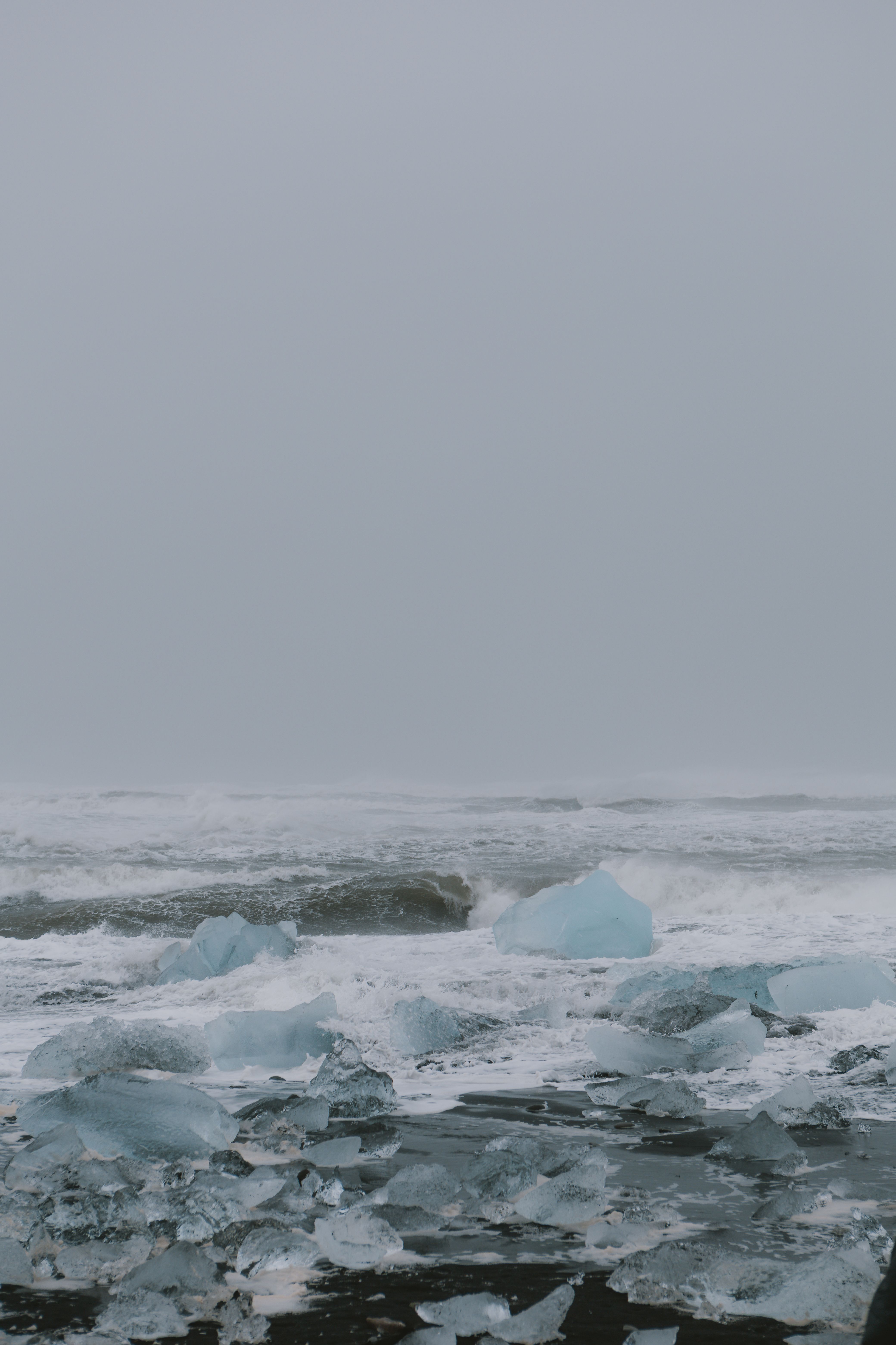 Icy Waves on a Dark Sand Beach at Twilight · Free Stock Photo