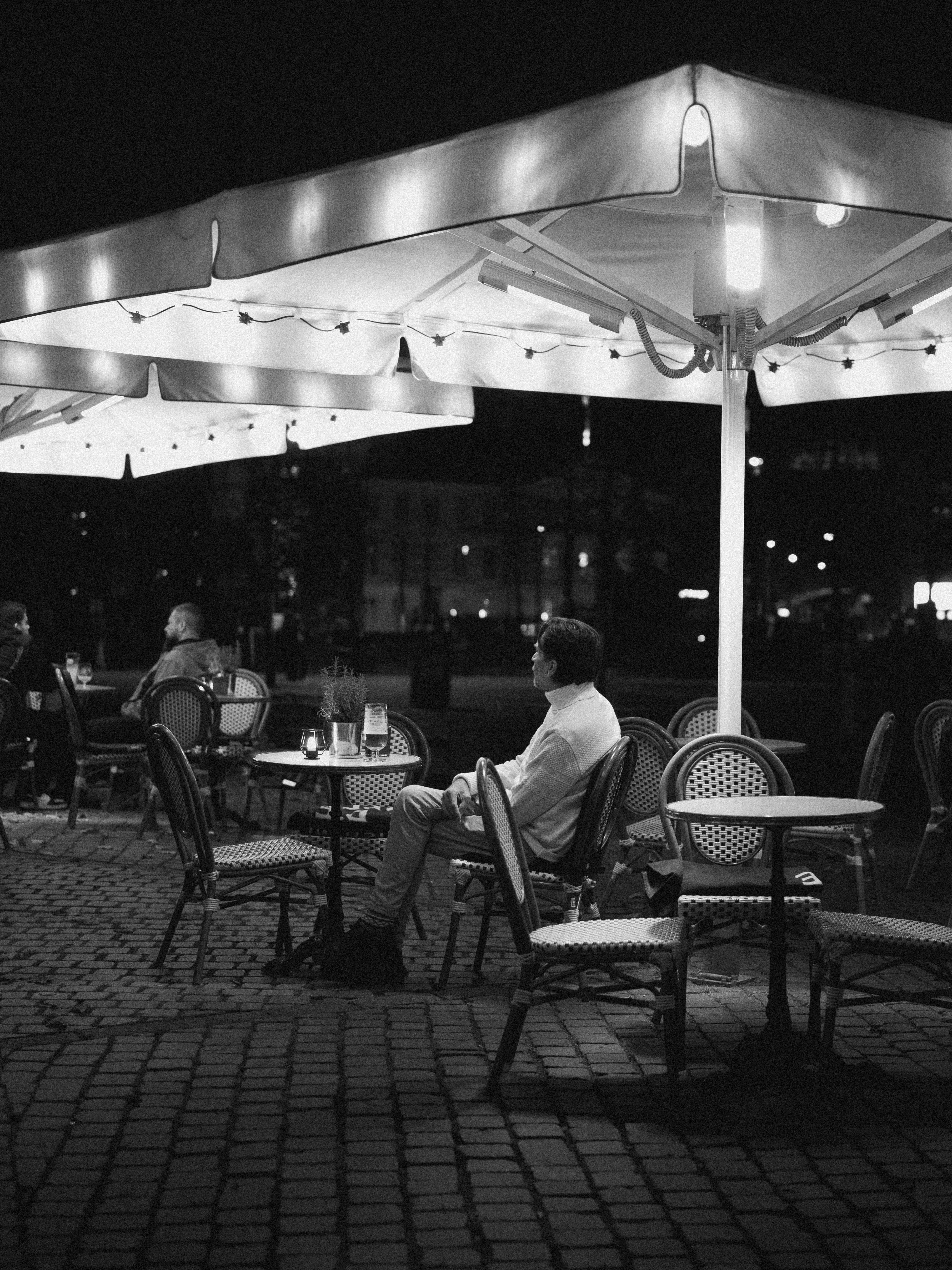Black and White Night Scene at Outdoor Café · Free Stock Photo
