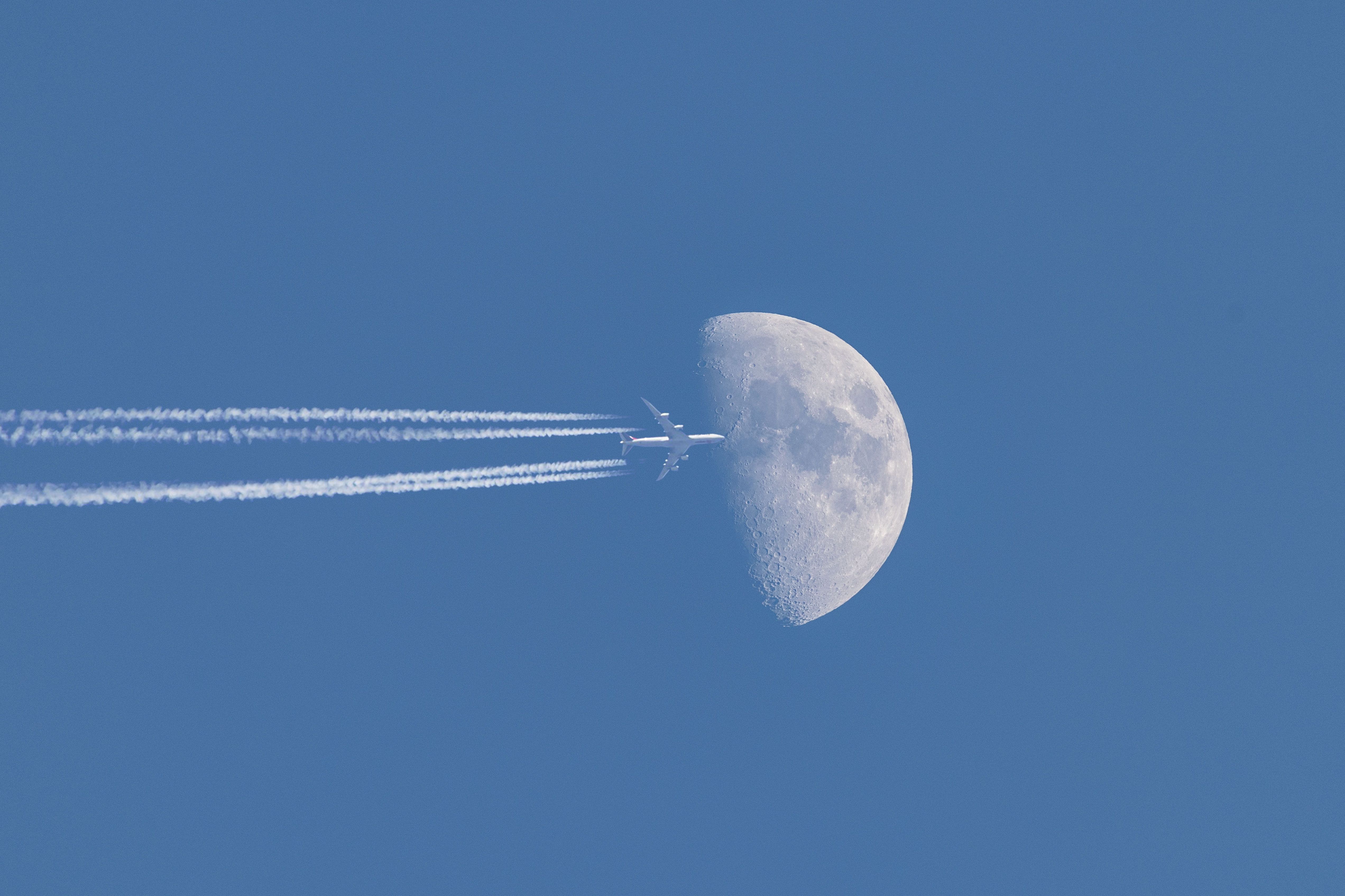 Airplane Crossing Bright Day Moon in Toronto Sky · Free Stock Photo
